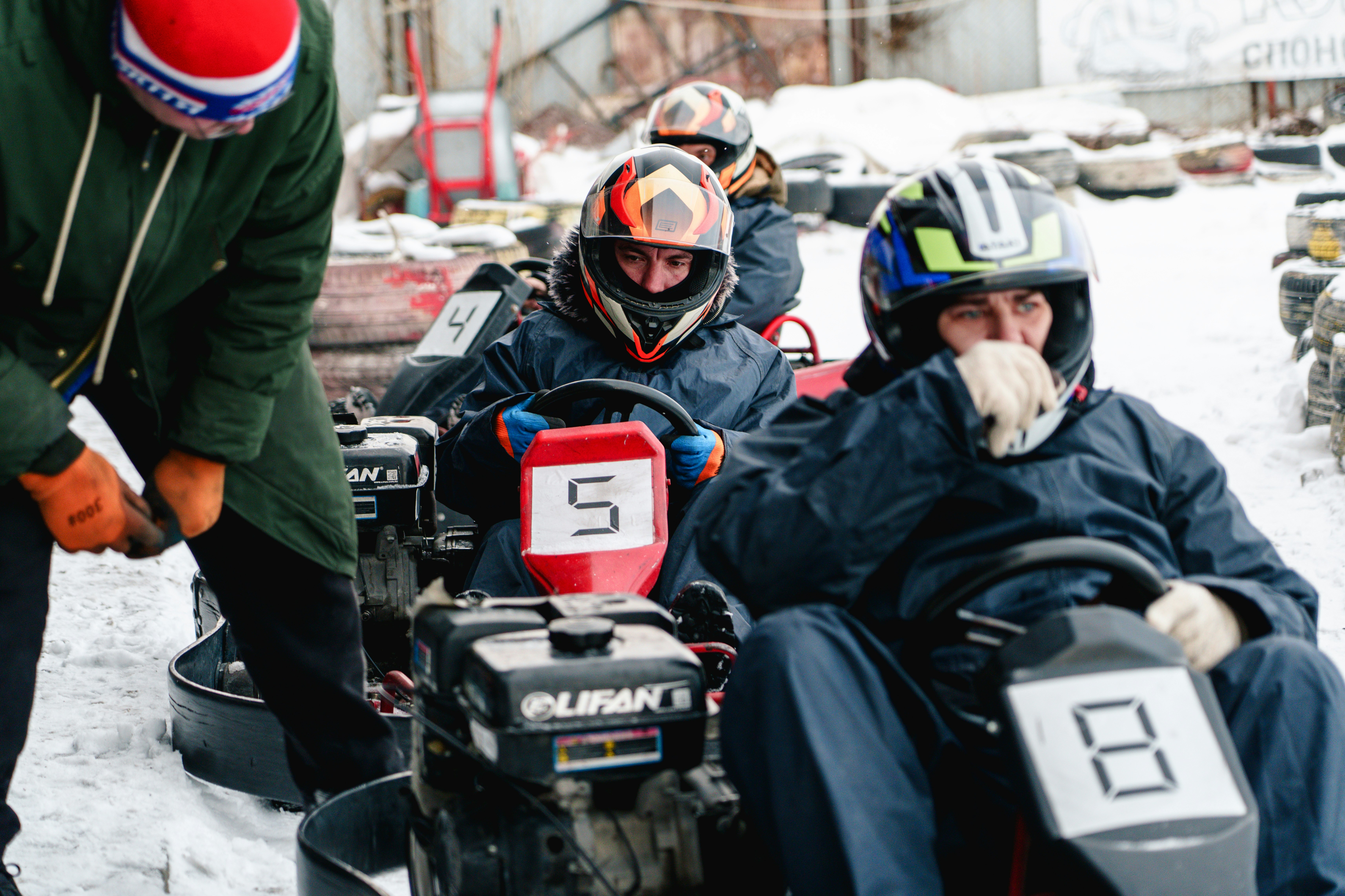 A group of people riding on top of snowmobiles photo – Free Helmet ...