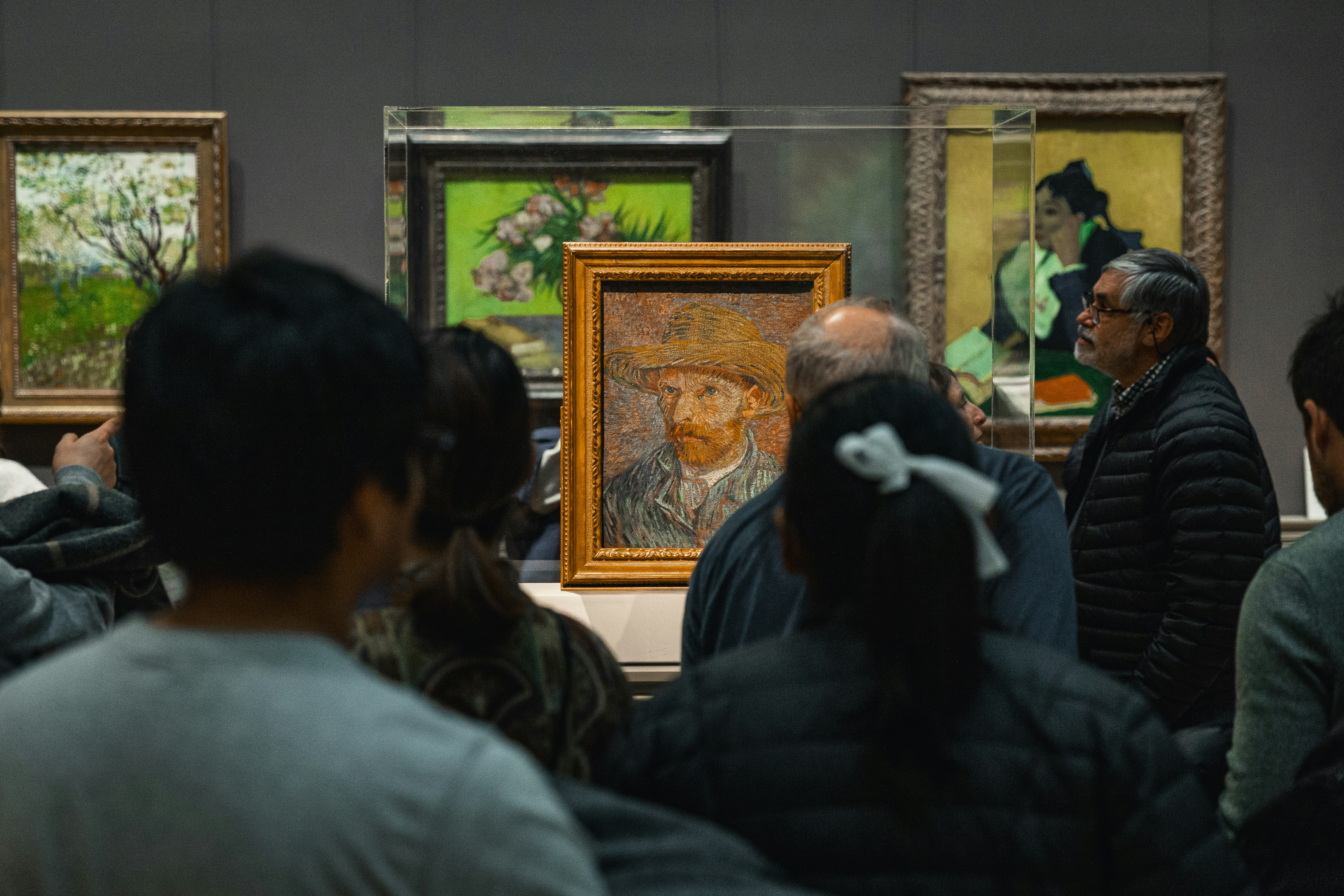 A group of people looking at paintings in a museum photo – Free New ...
