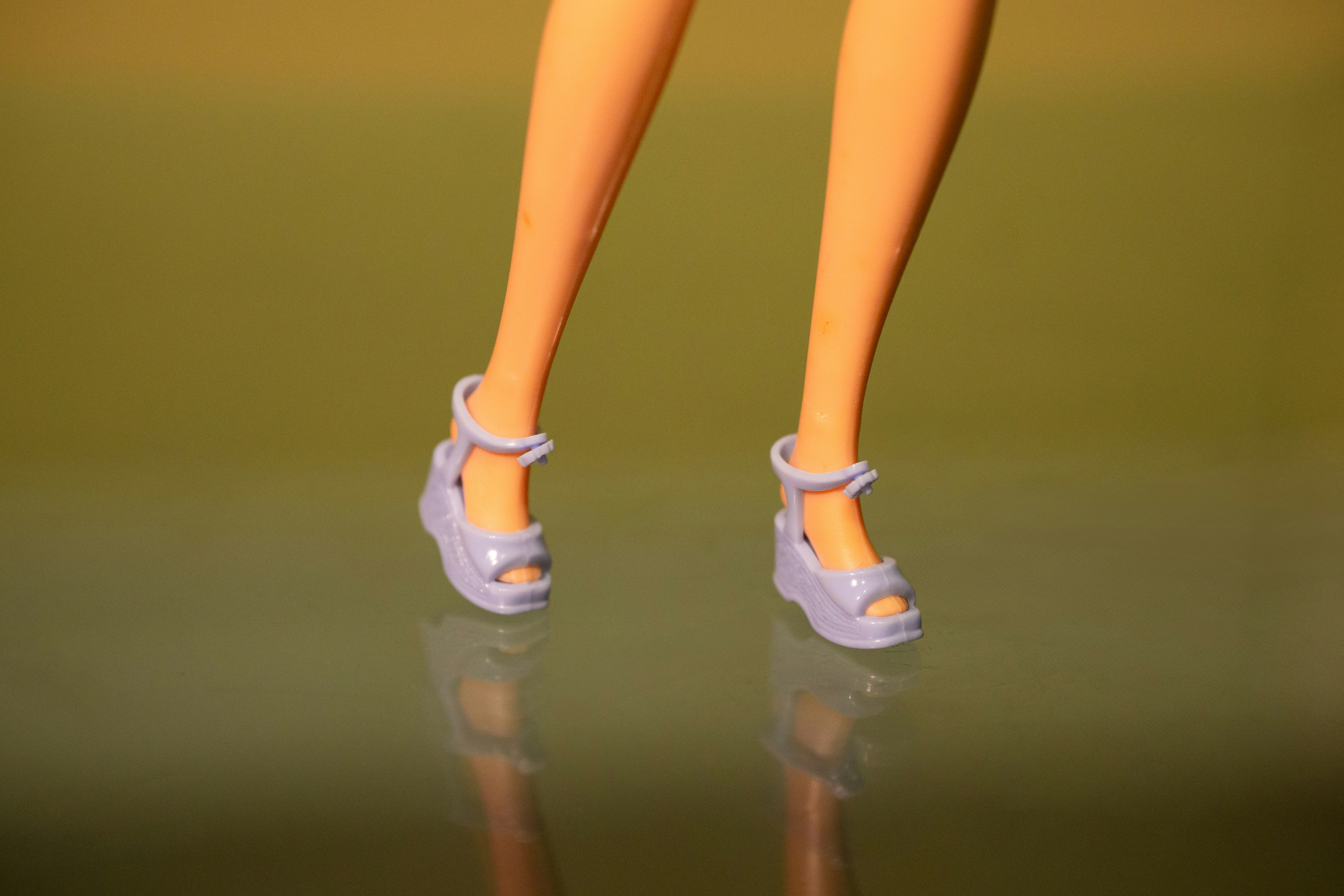 A close up of a doll's legs and shoes