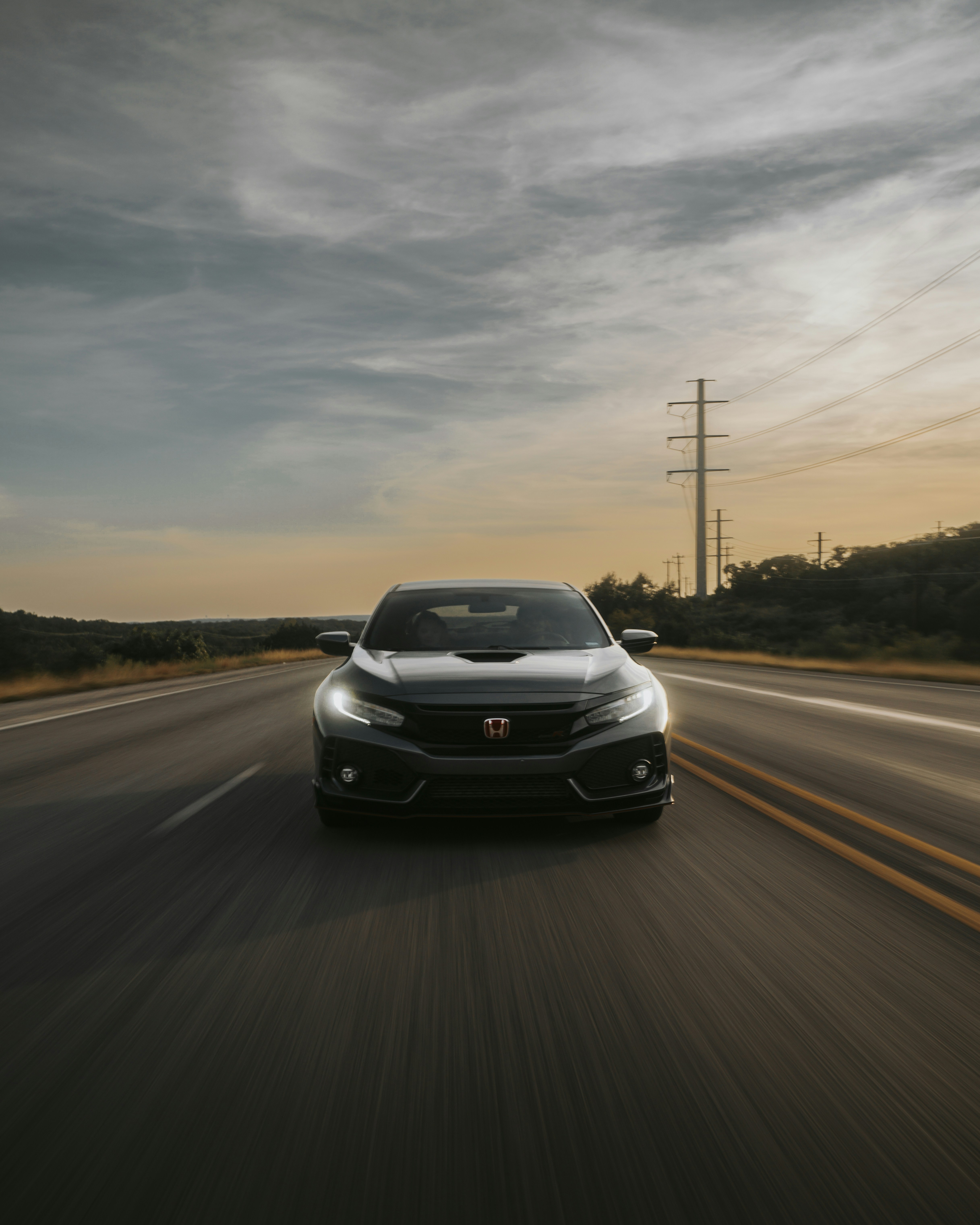 A car driving down a road with a sky background photo – Free Civic type ...