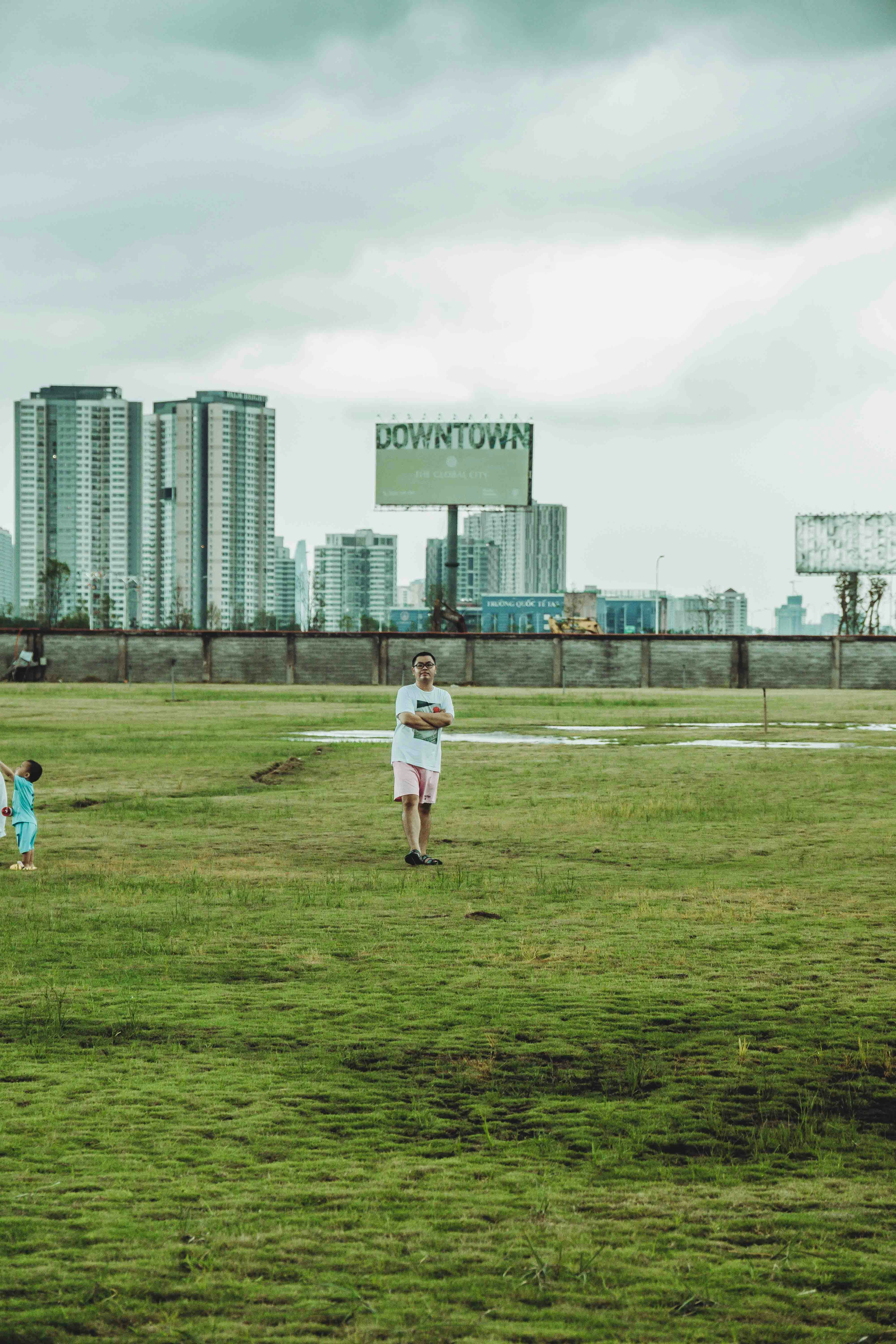 Center Field, Cityscape: A Quiet Figure Against the Downtown Horizon