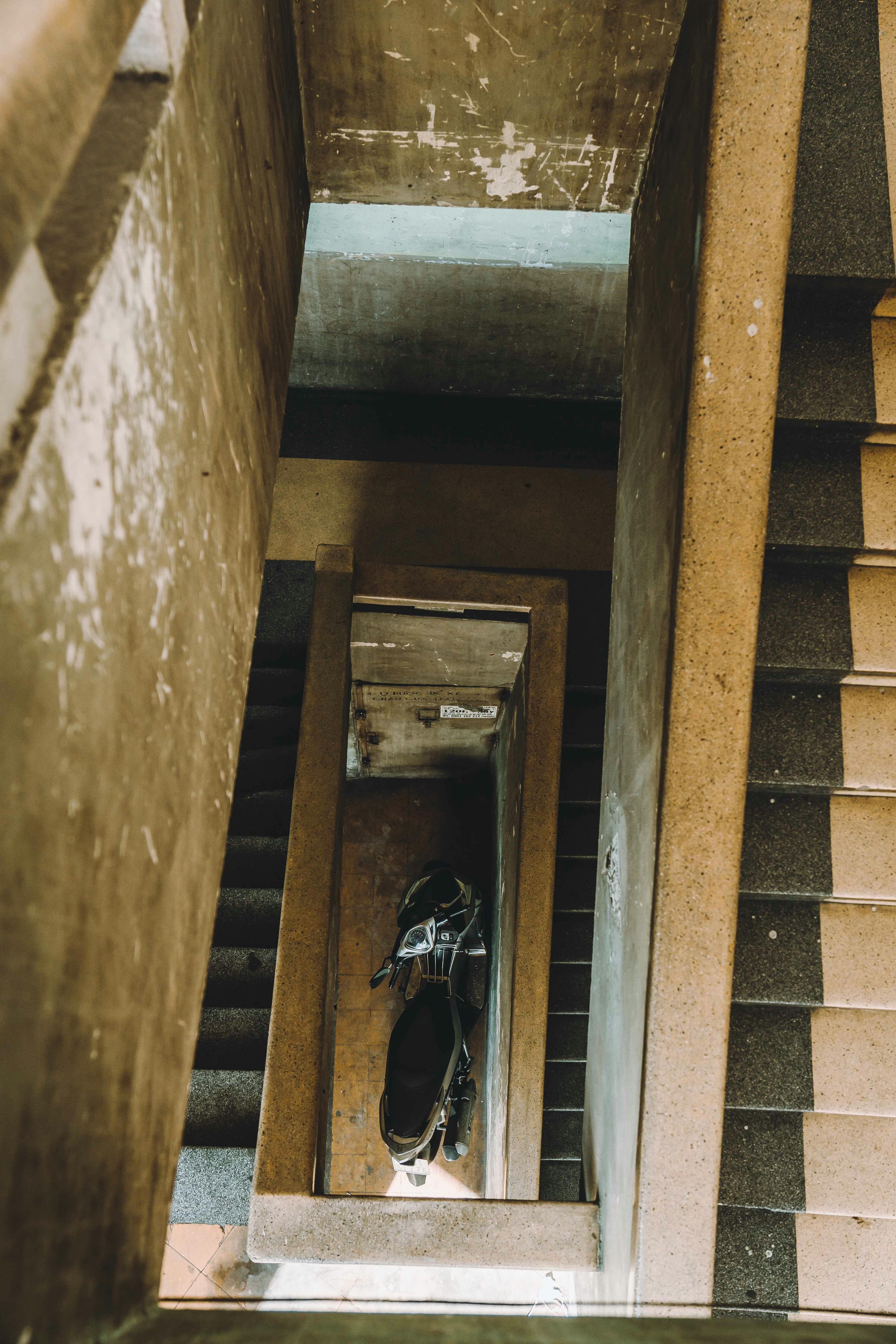 Bike at the Core of a Concrete Stairwell: A Descent Through Angles