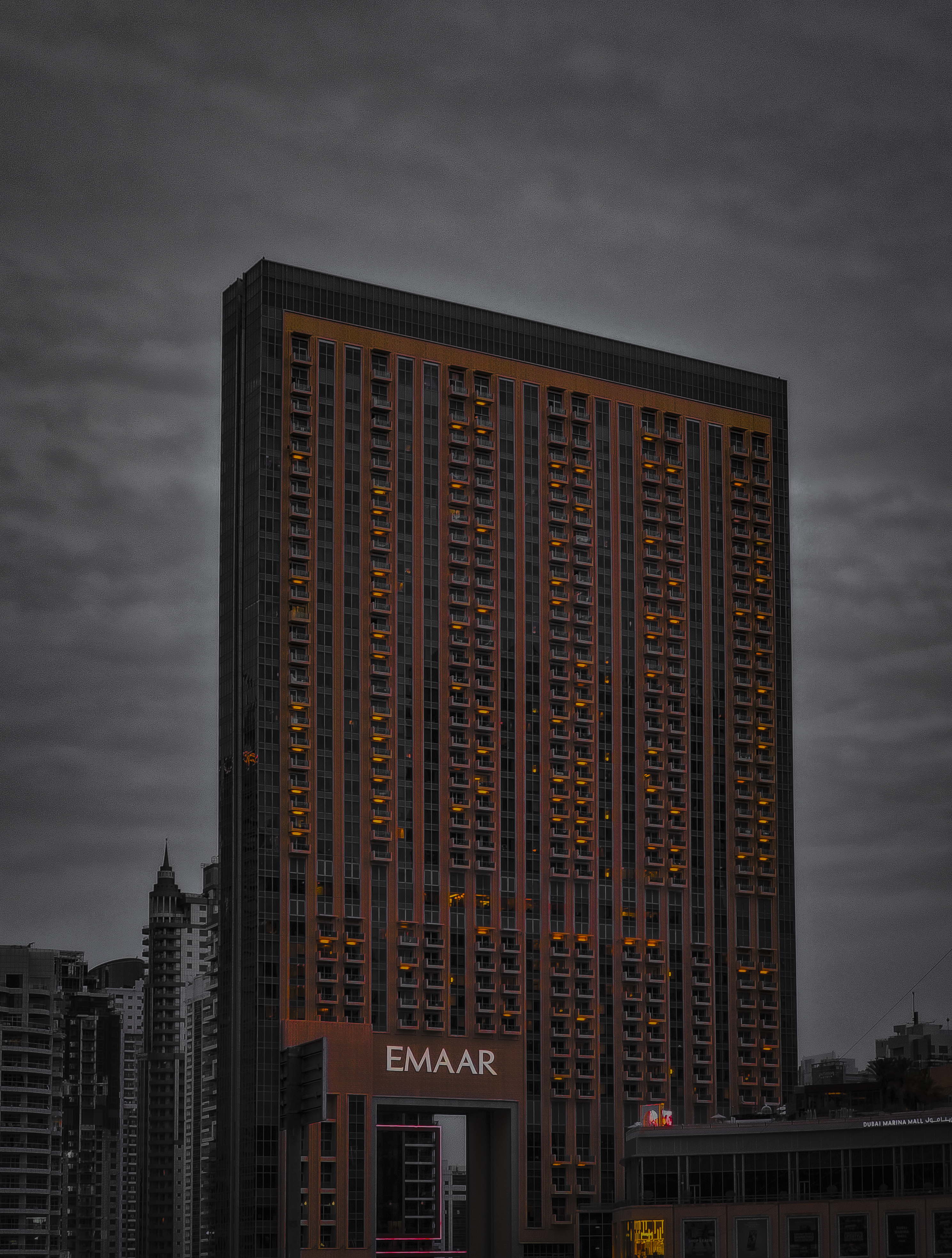 Monolithic EMAAR: a dusk-lit tower piercing a cloudy night
