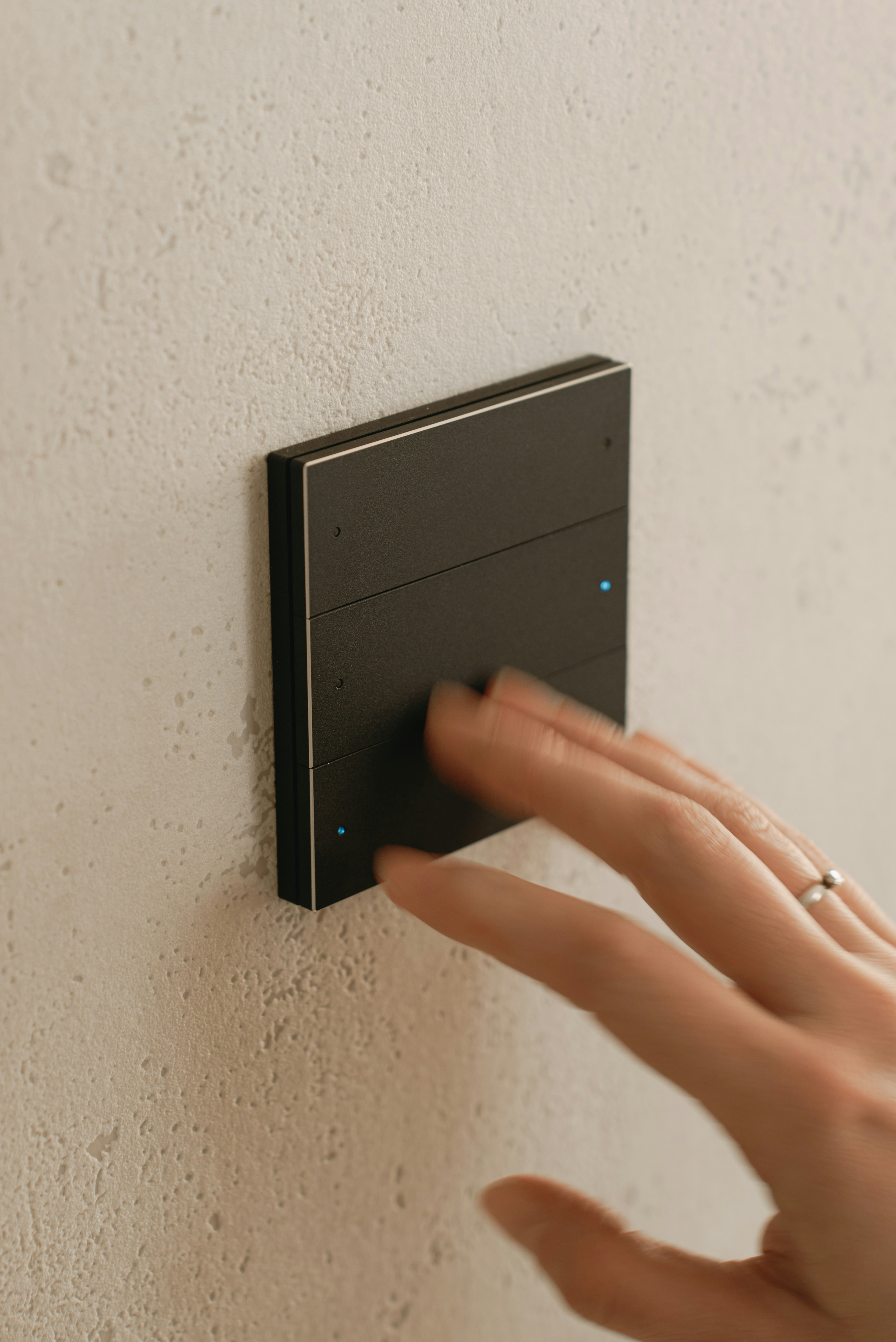 A person's hand touching a button on a wall photo – Free Wall Image on ...