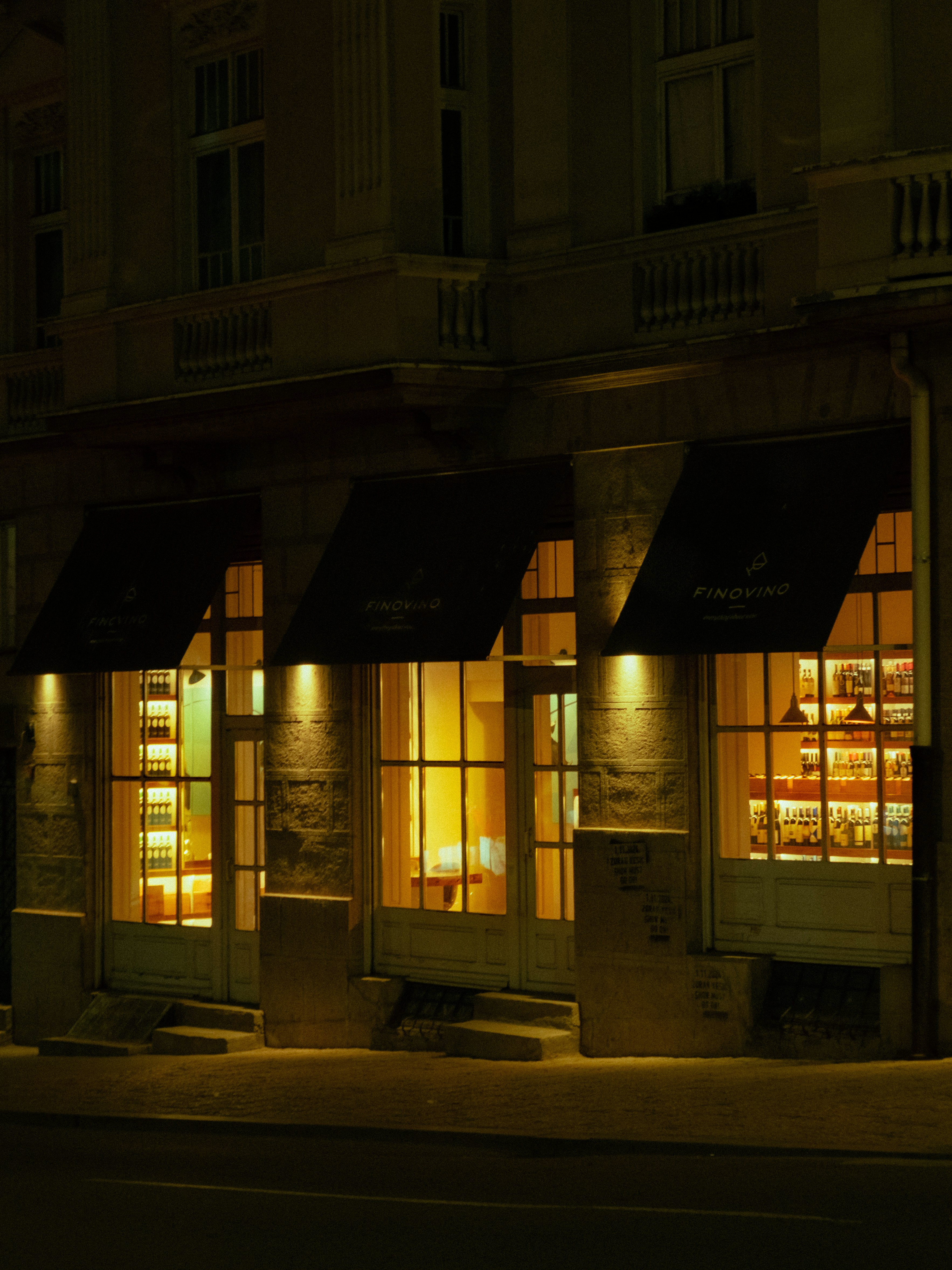 A store front at night with lit up windows photo – Free Belgrade Image ...
