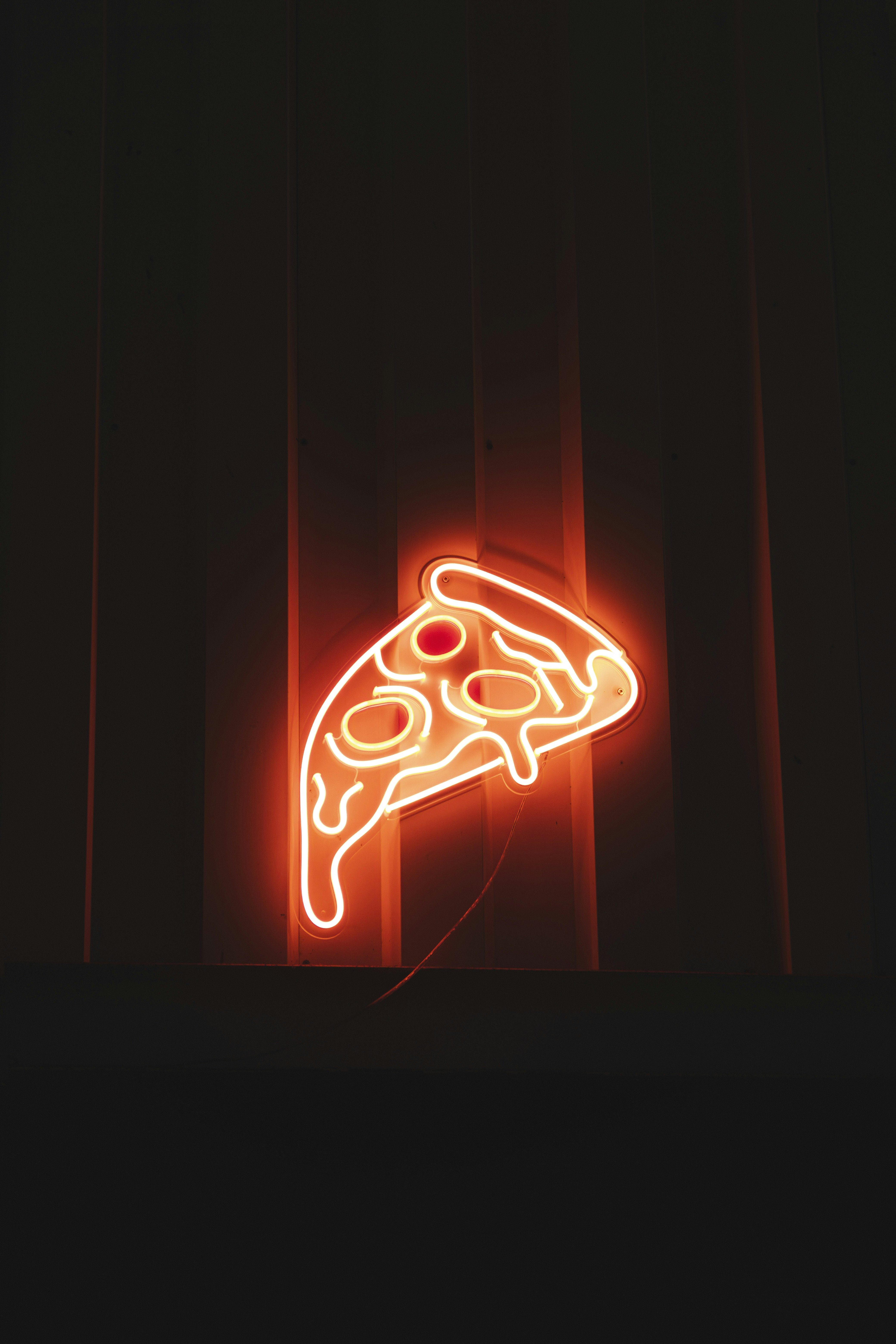 A neon pizza sign is lit up in the dark photo – Free Light Image on ...