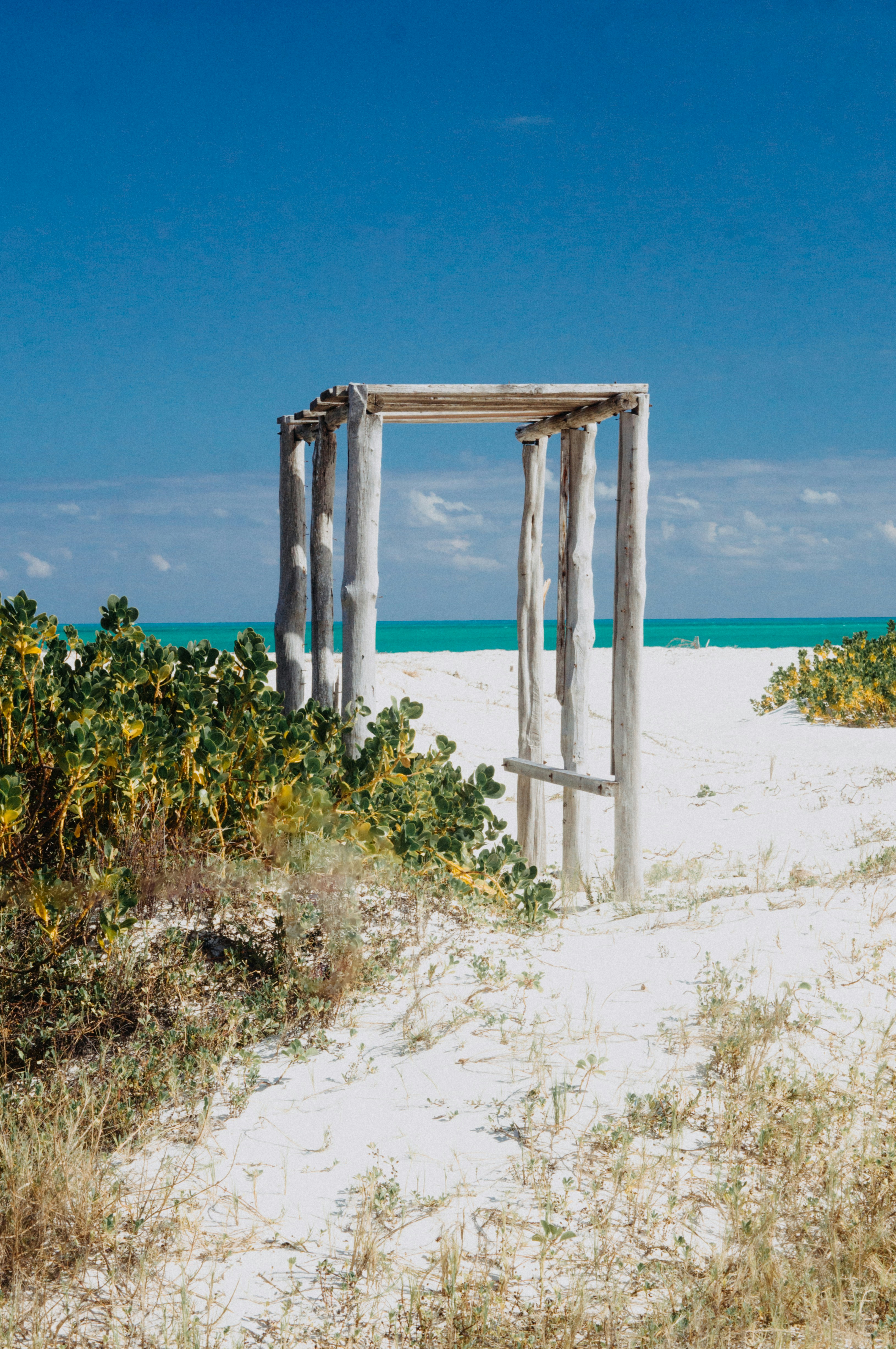 A wooden gate on a sandy beach near the ocean photo – Free Beach Image ...