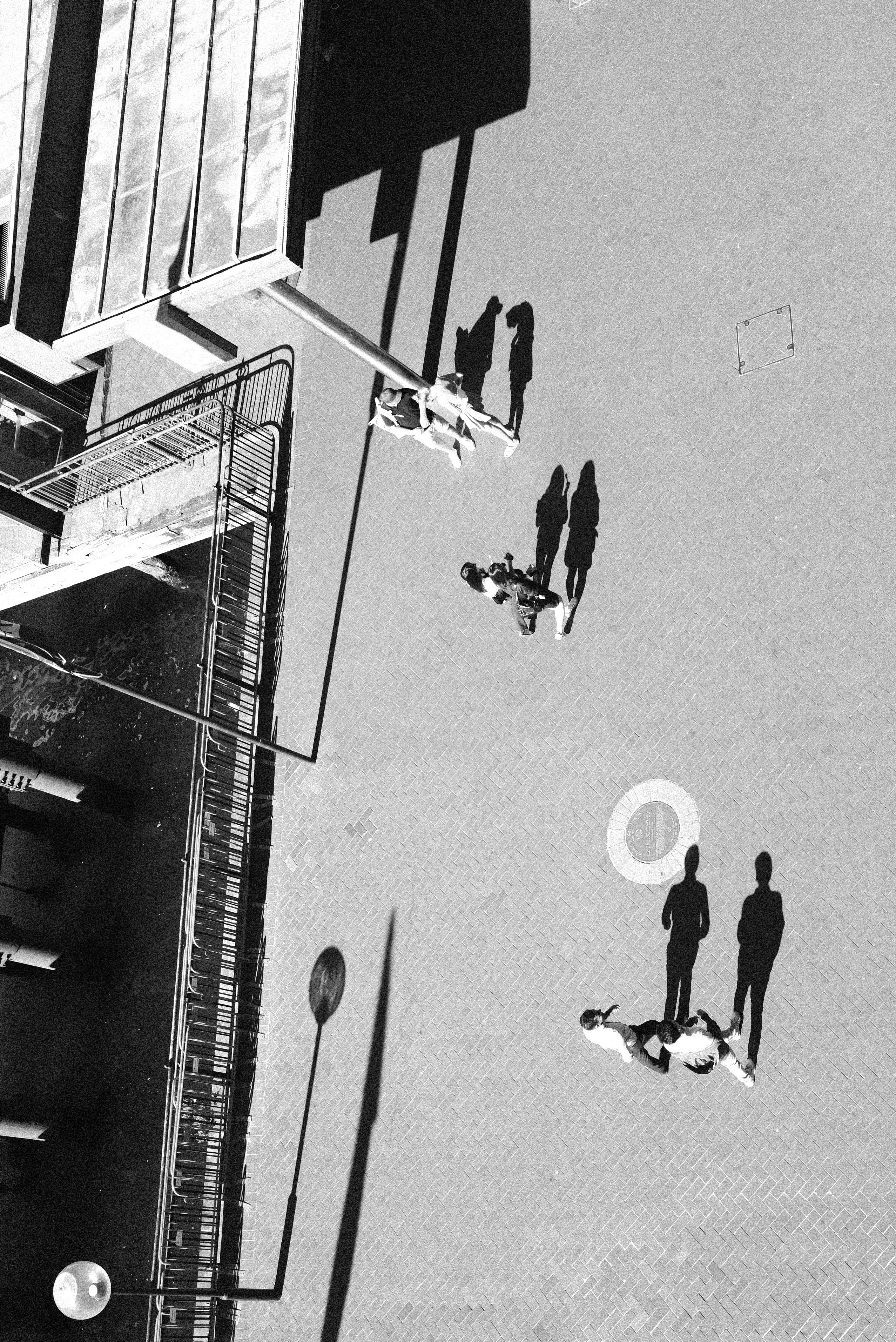 Shadowed silhouettes on a sunlit plaza: a diagonal urban study