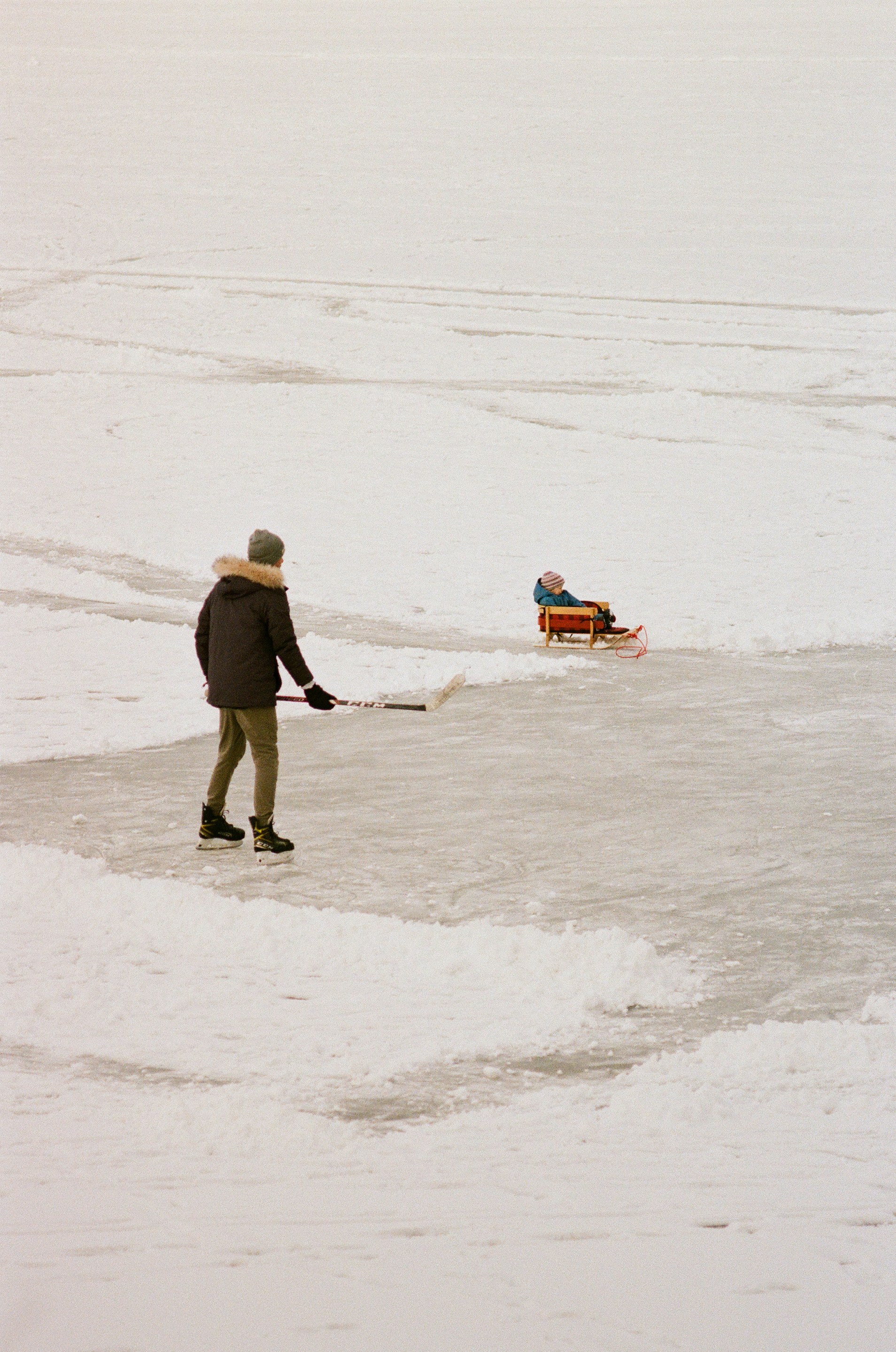 A man pulling a sled across a frozen lake photo – Free Man Image on ...