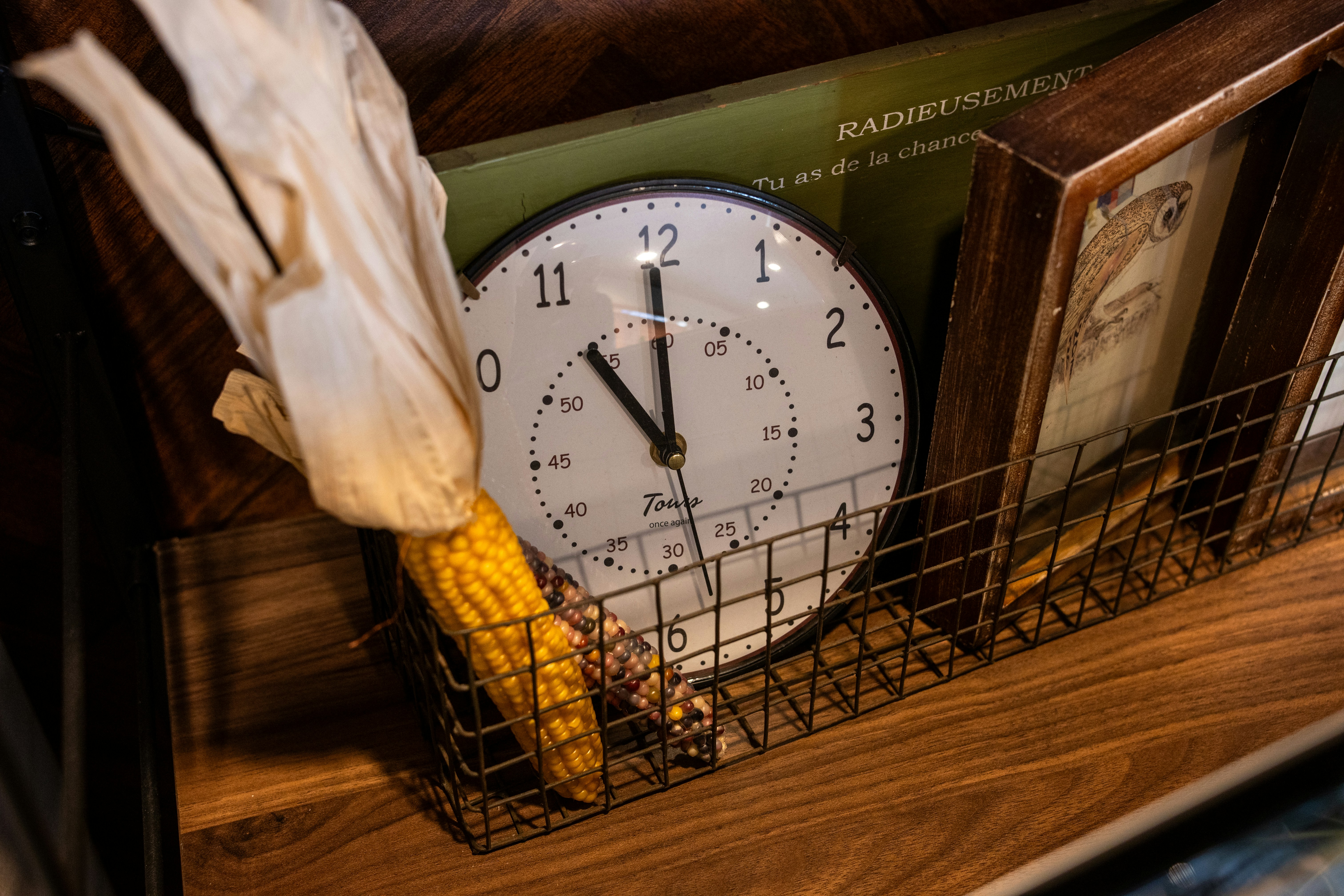 Timekeeper in a Rustic Nook: Clock, Corn, and Glove in a Warm Still-Life