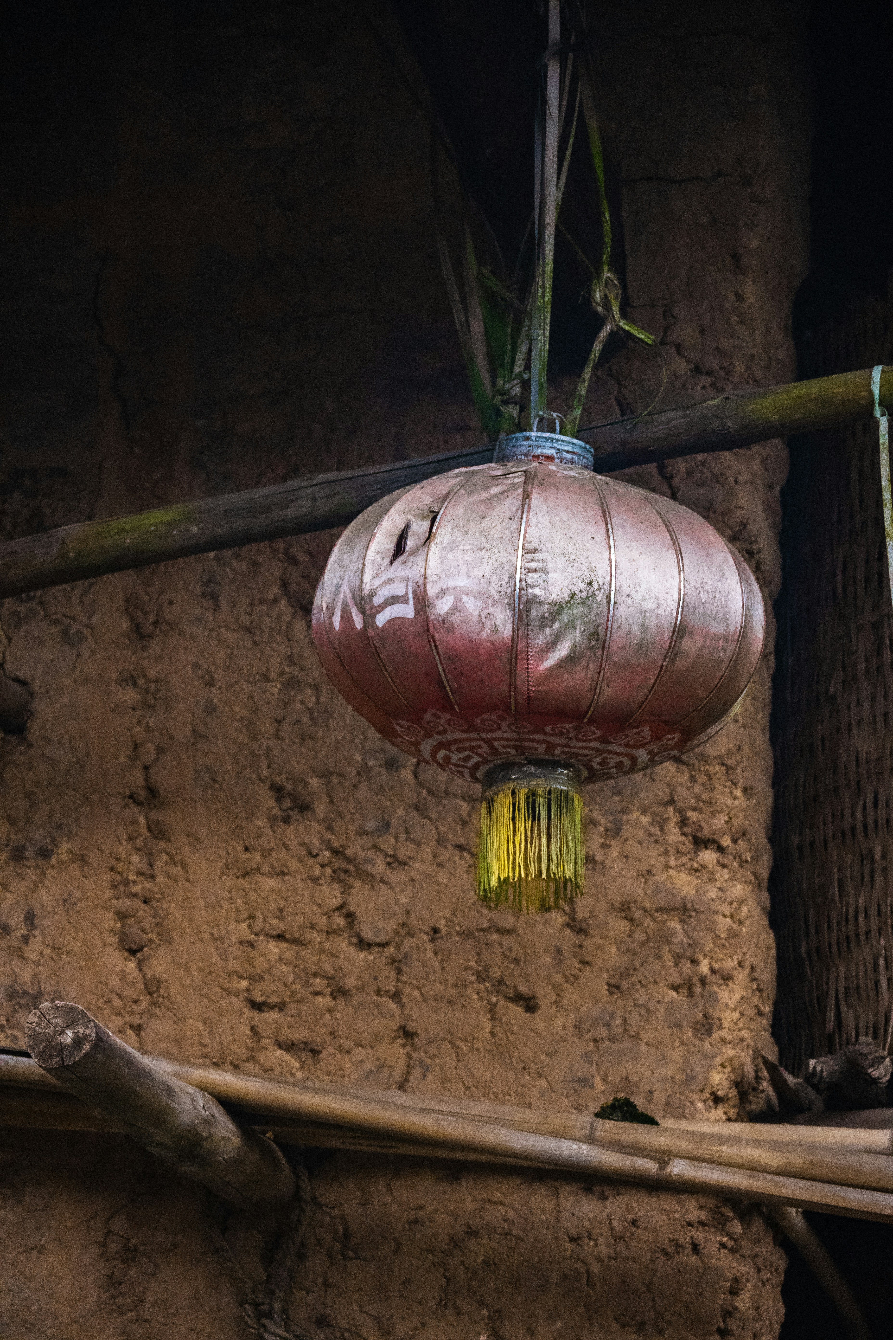 Crimson Lantern Over Mudbrick Wall: A Quiet Textural Study