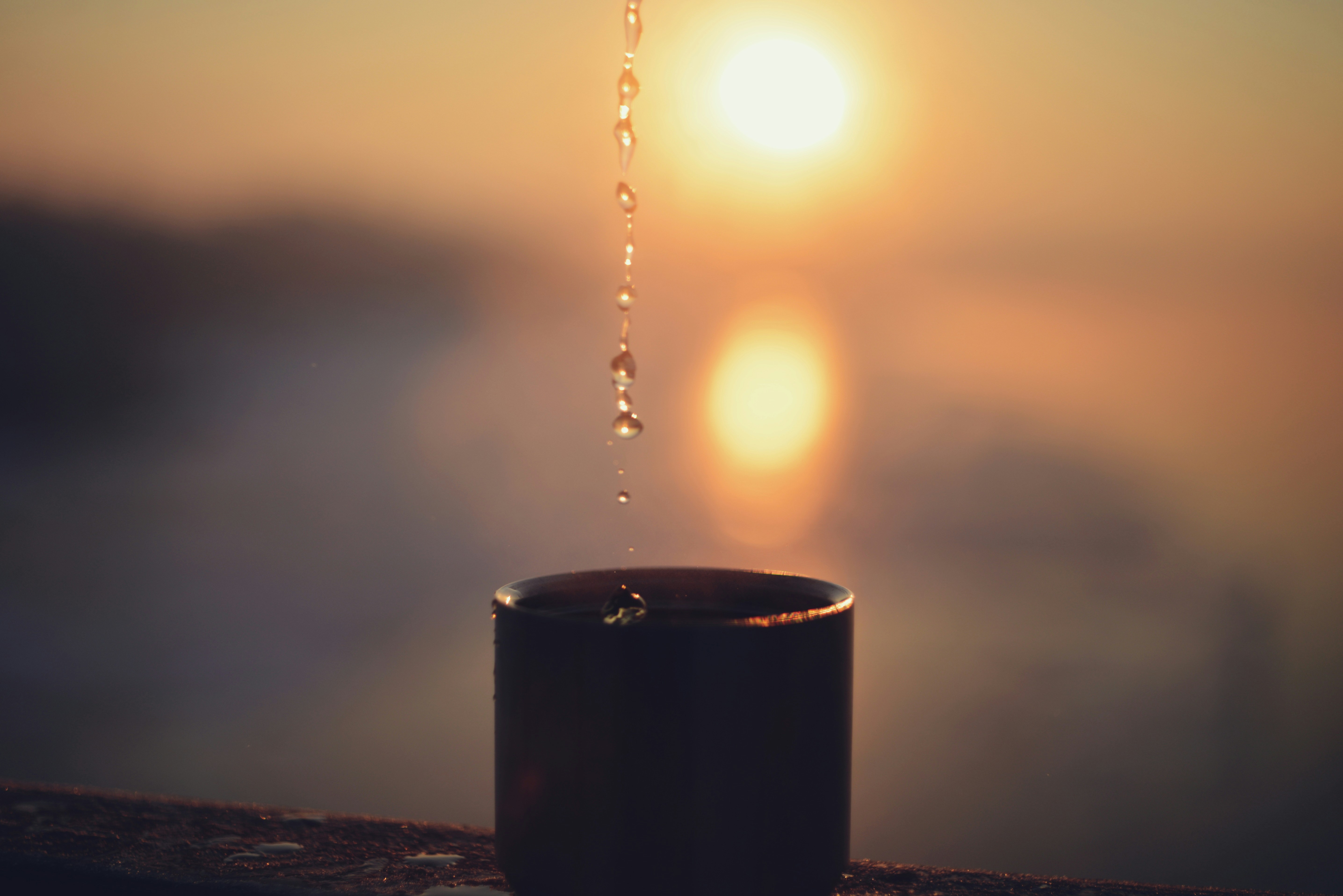 Dusk Drips: A Solitary Cup Meets the Golden Stream