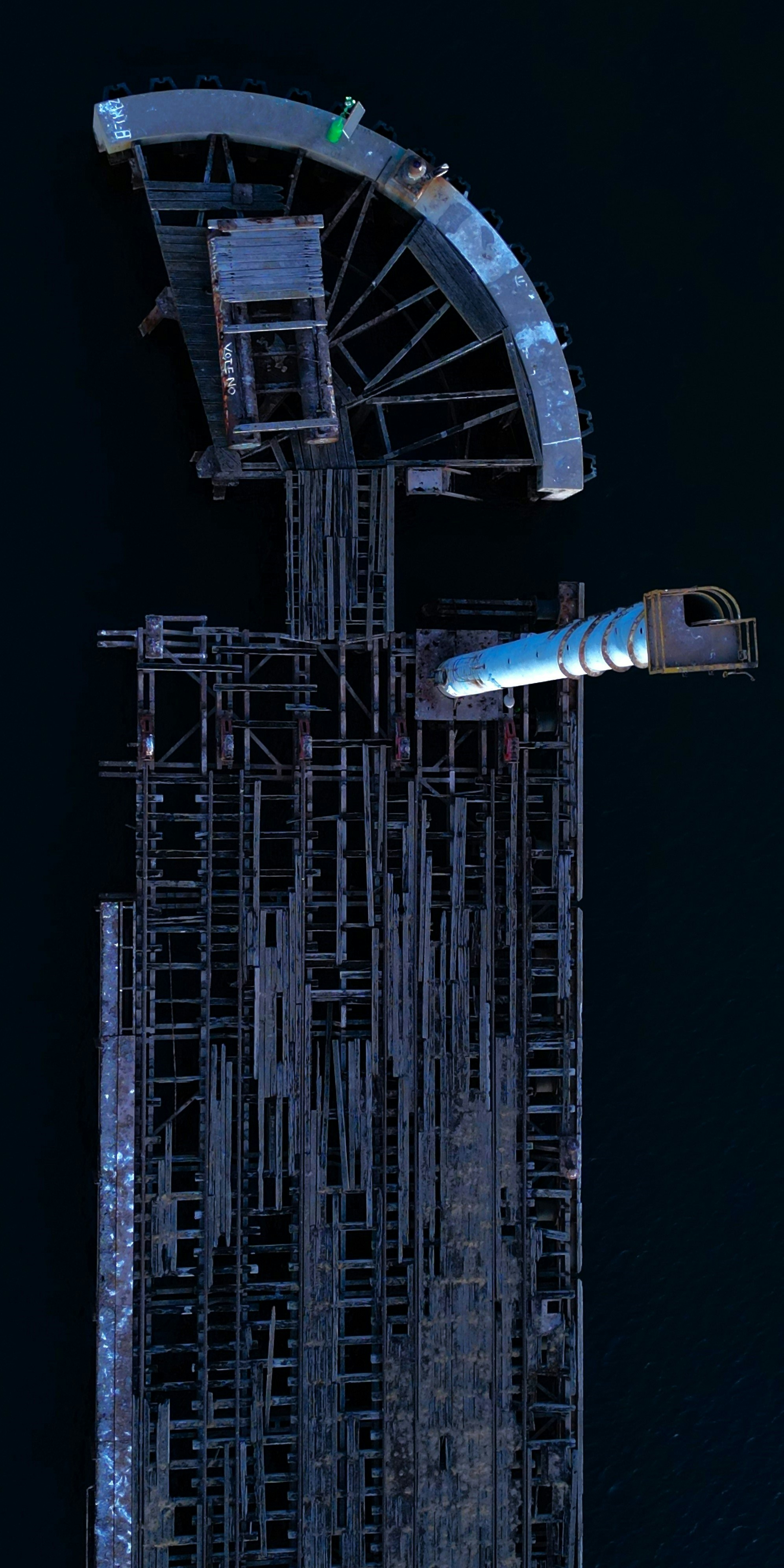 Aerial Portrait of a Deteriorated Pier Structure Reaching into Dark Waters