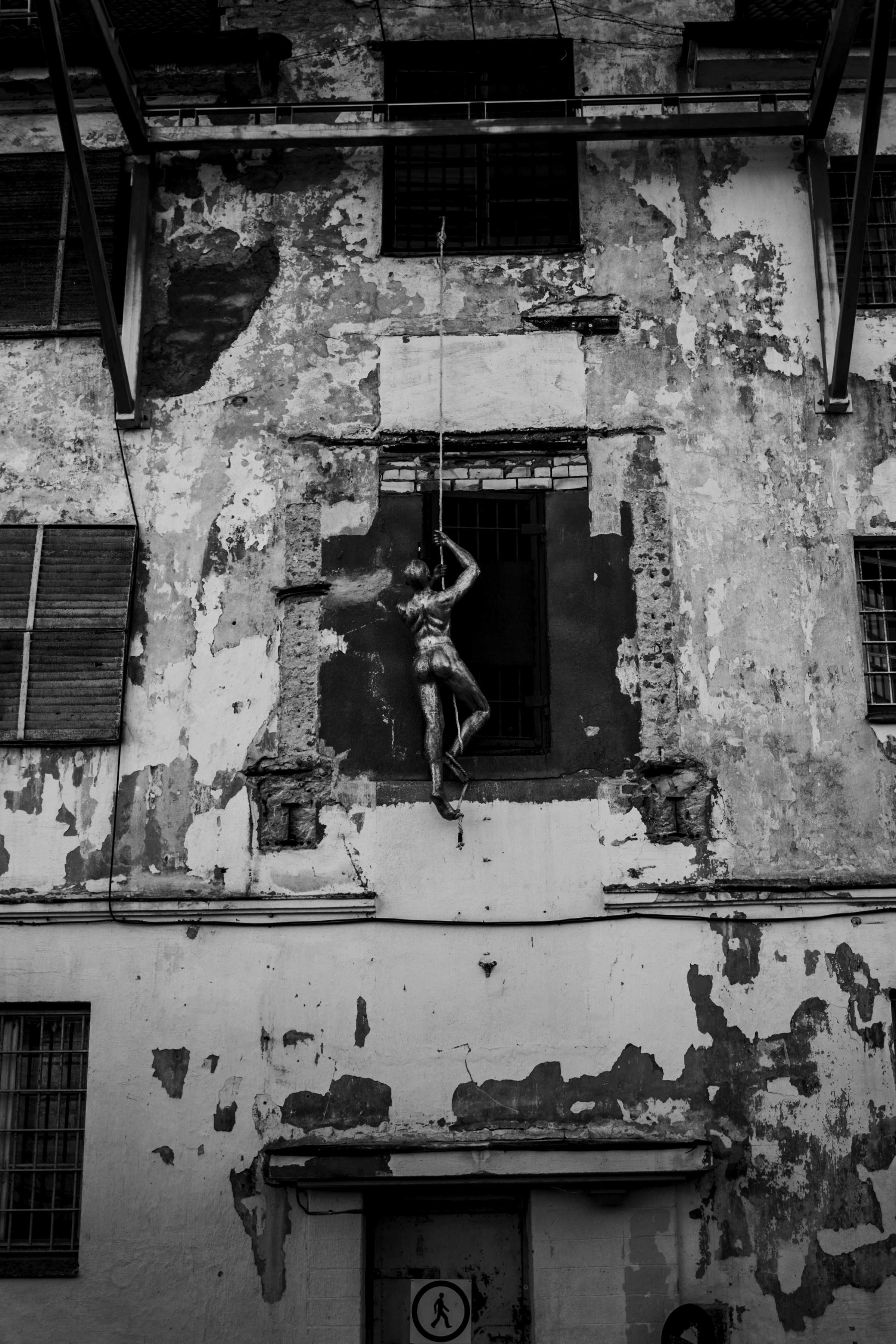 Rope Climber Rising from a Crumbling Facade