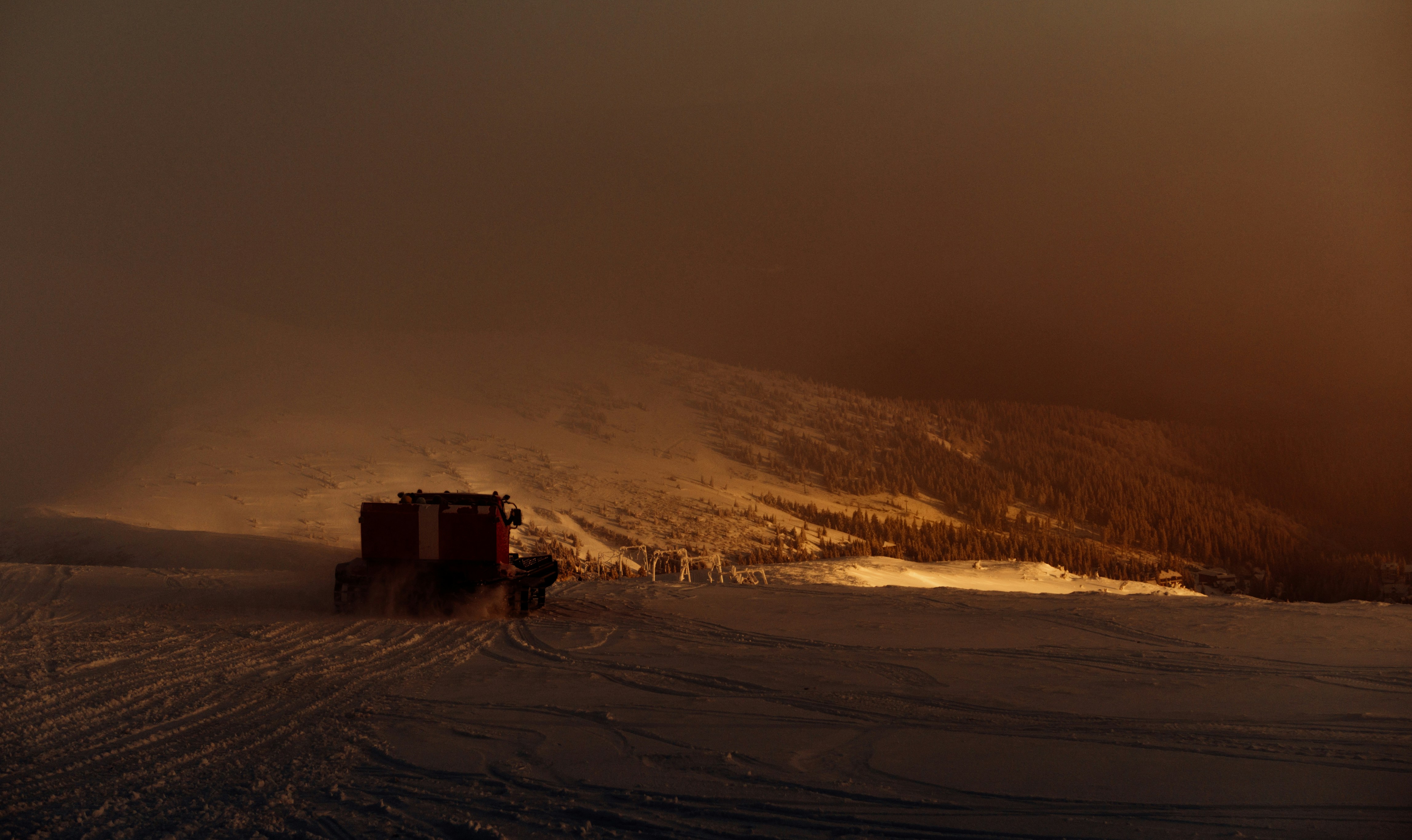 Golden Horizon: Snowcat Journey at Dawn