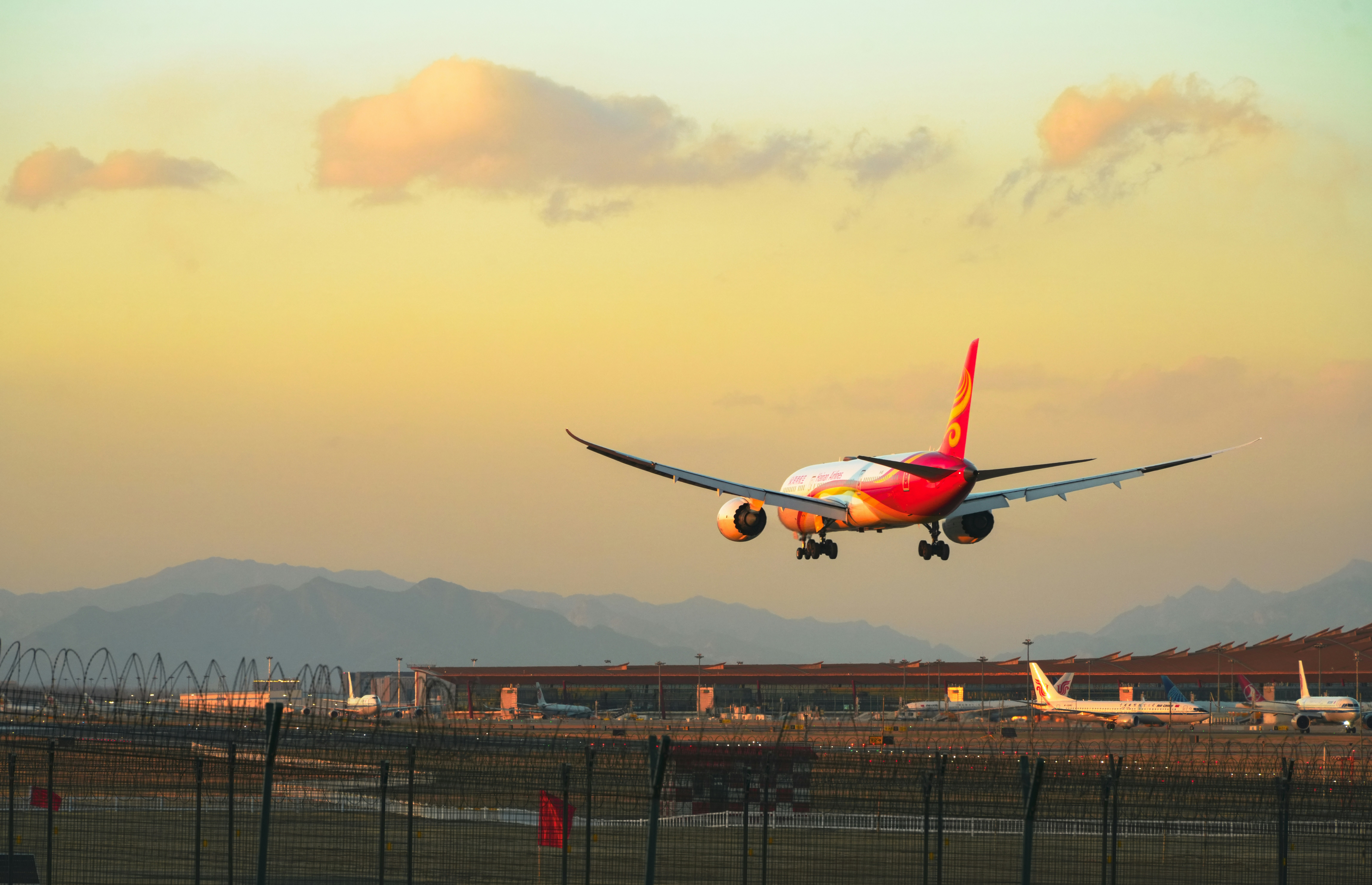 Sunlit Return: A Jet Lifts Off Over the Airport Fence at Dusk