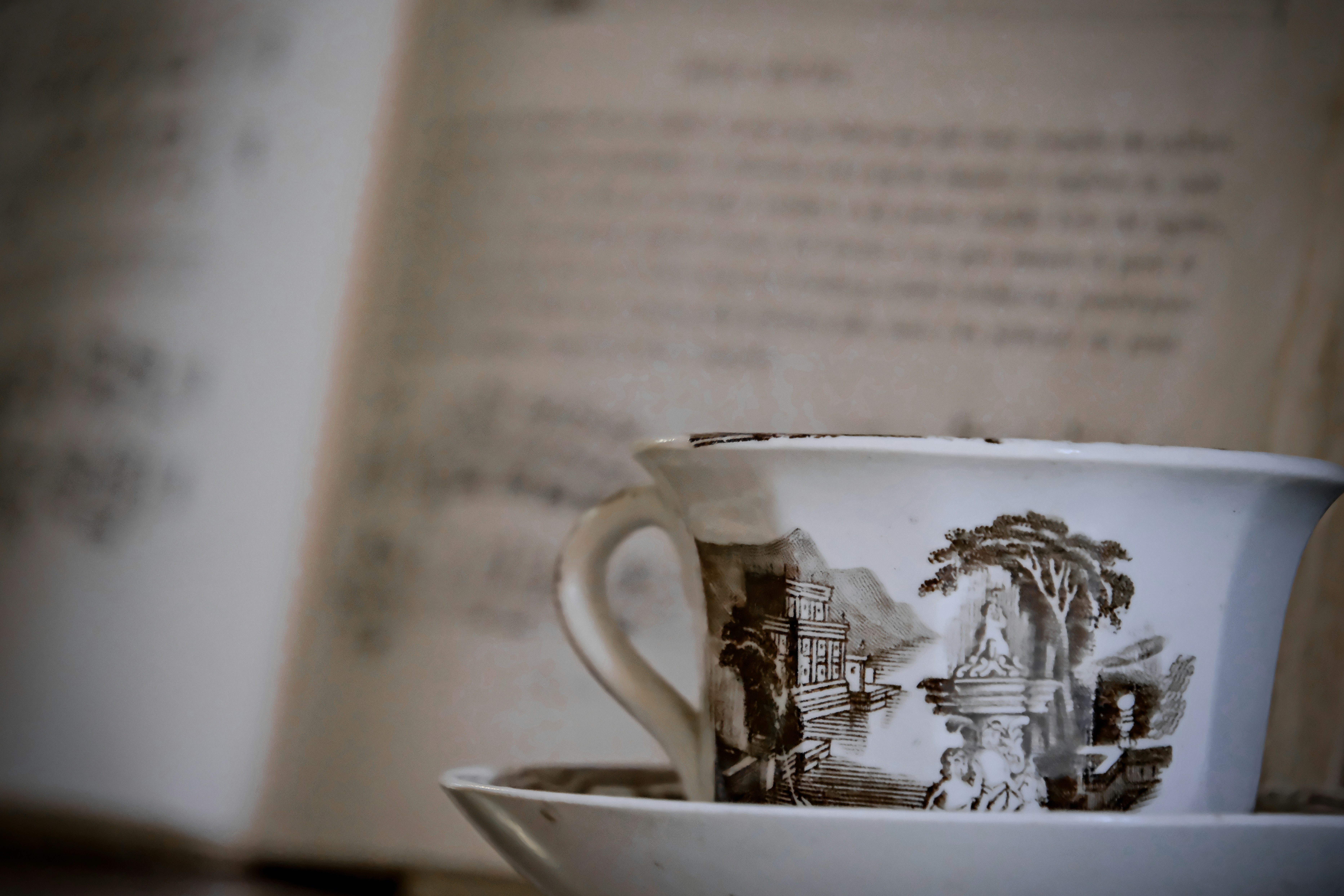 Ink on Porcelain: A Quiet Cup Framed by Folded Pages