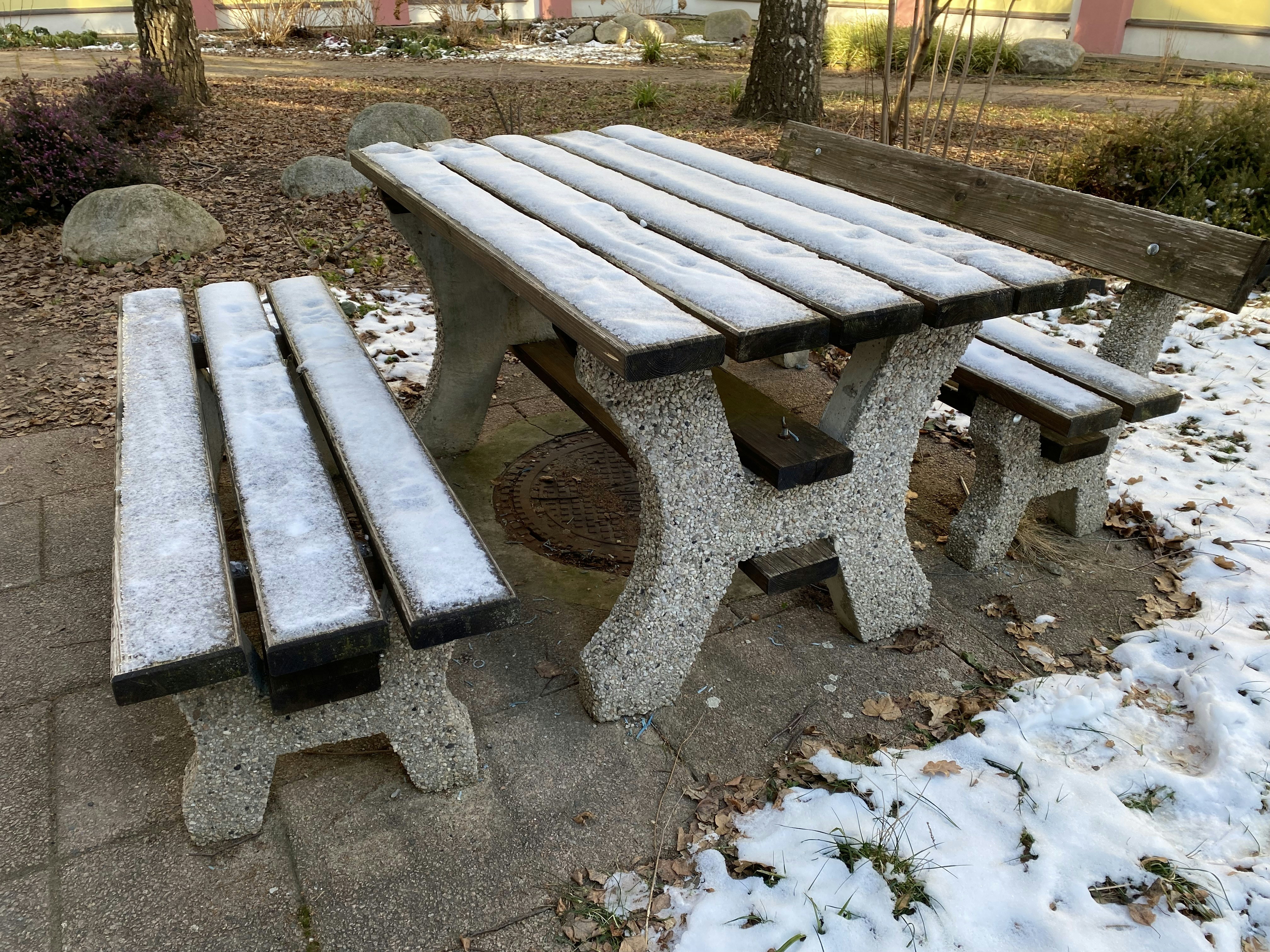 Snow-Dusted Picnic Table in a Quiet Park Corner