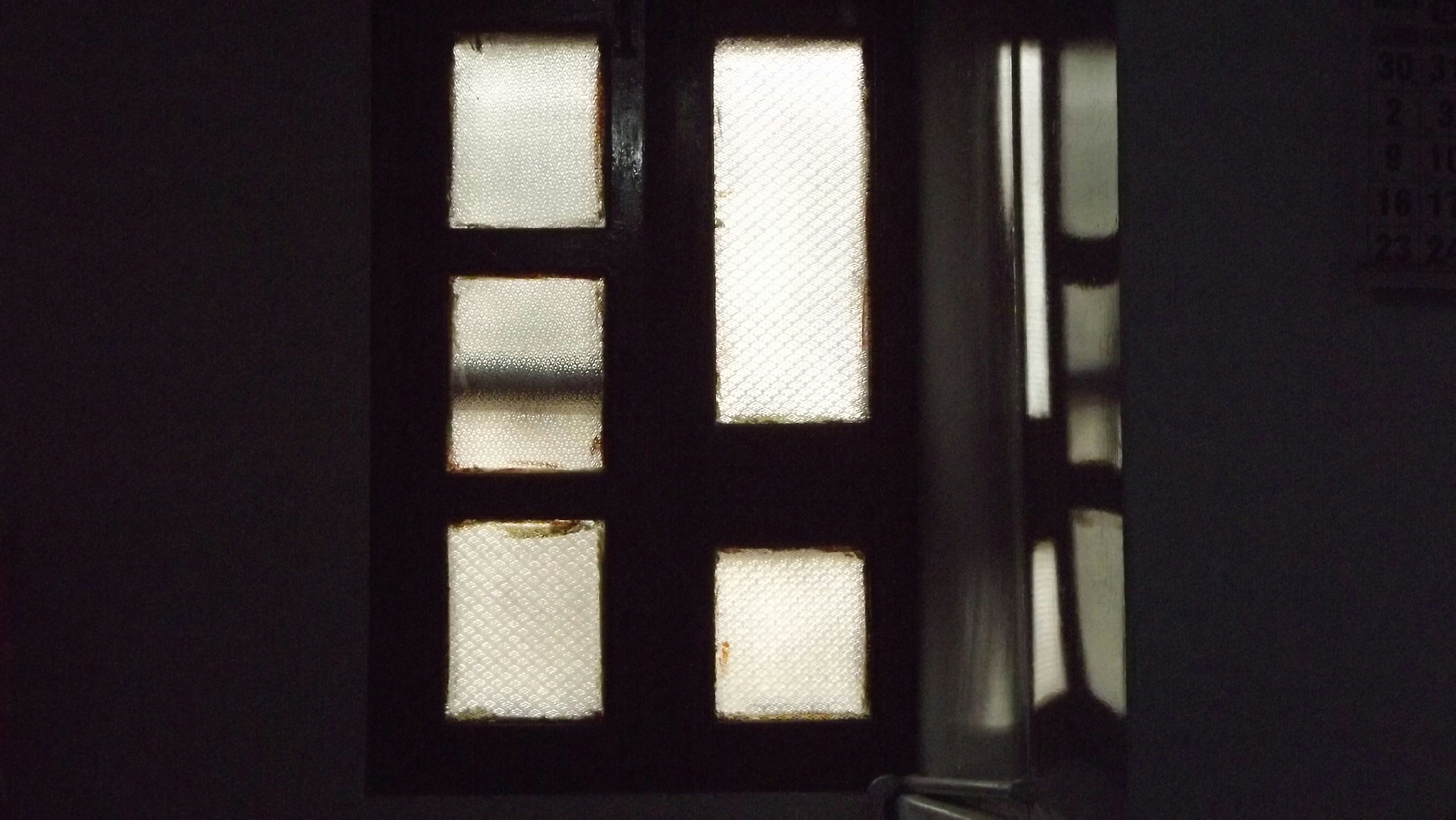 Backlit Grid of Windowpanes in a Dim Corridor