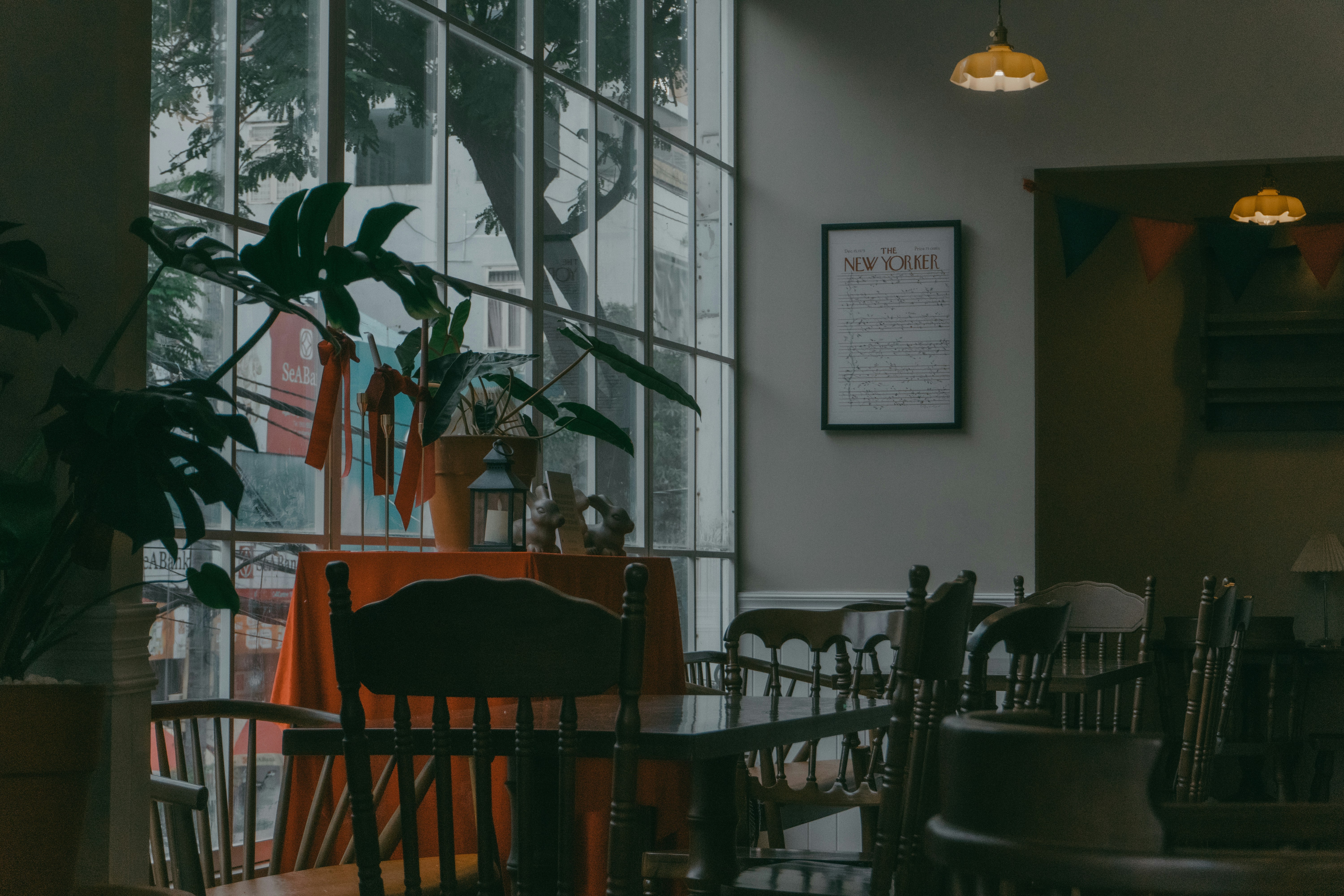 A table and chairs in a room with large windows