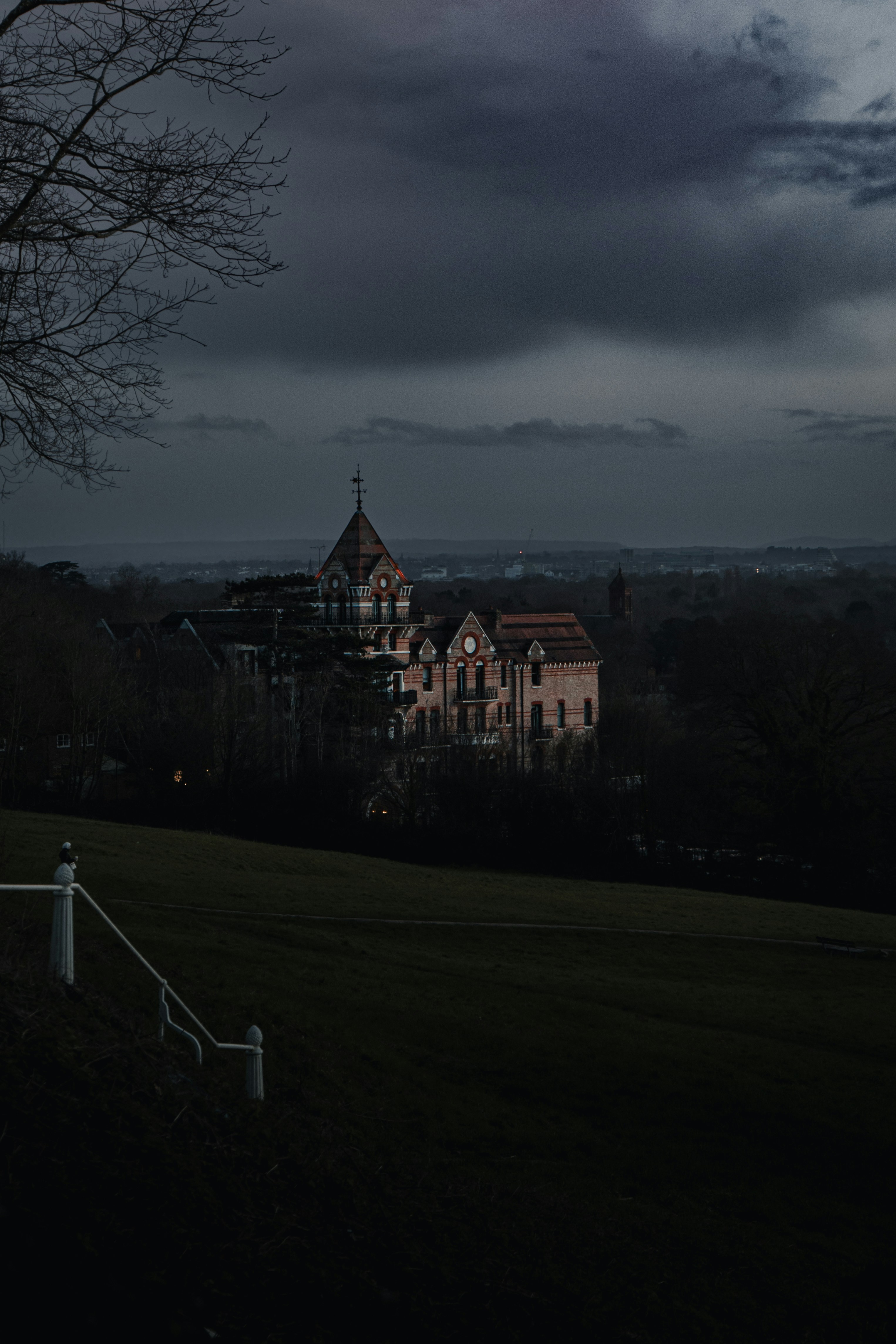 A large building sitting on top of a lush green field