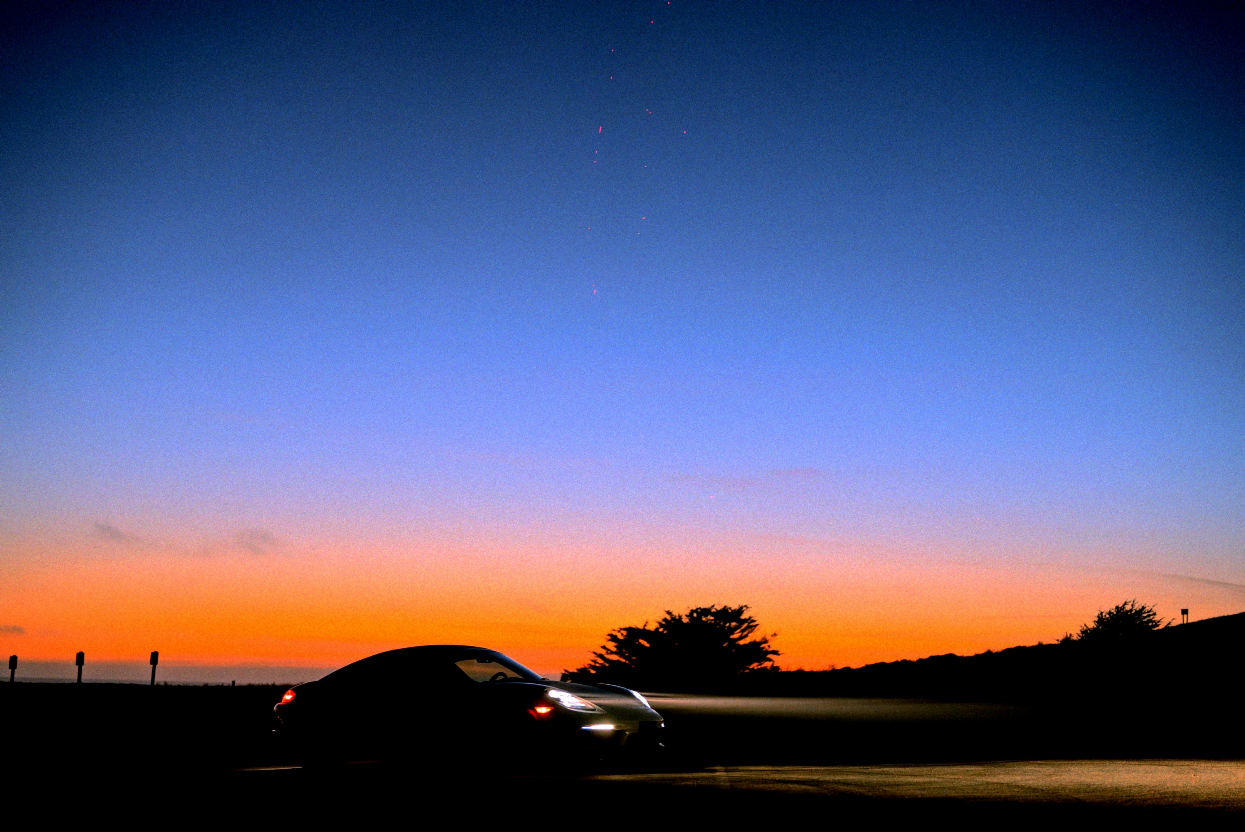 Horizon Run: A Car Silhouette Against Twilight