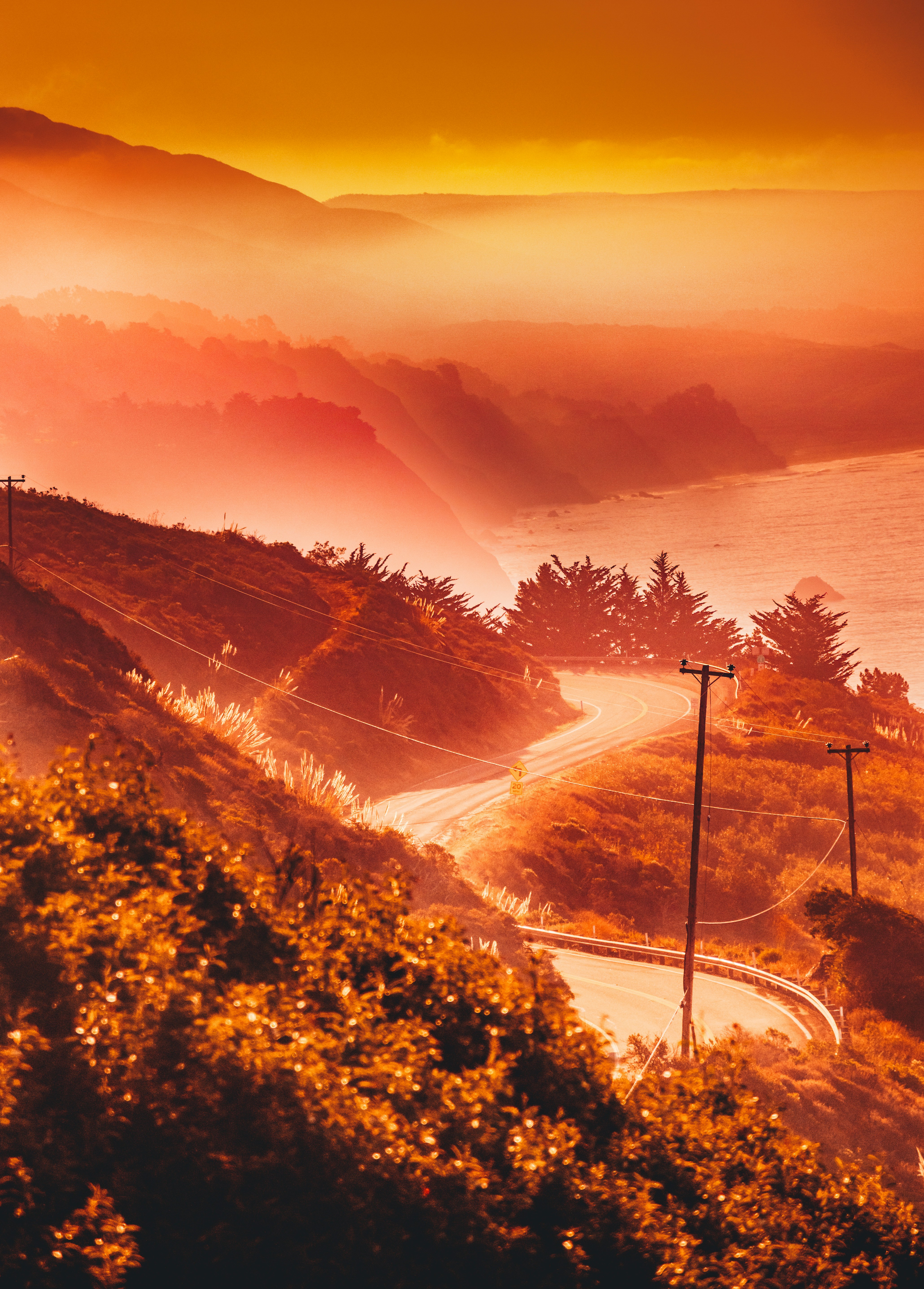 Ember-Coast Ribbon: A Winding Road Carved Through Sunset Haze