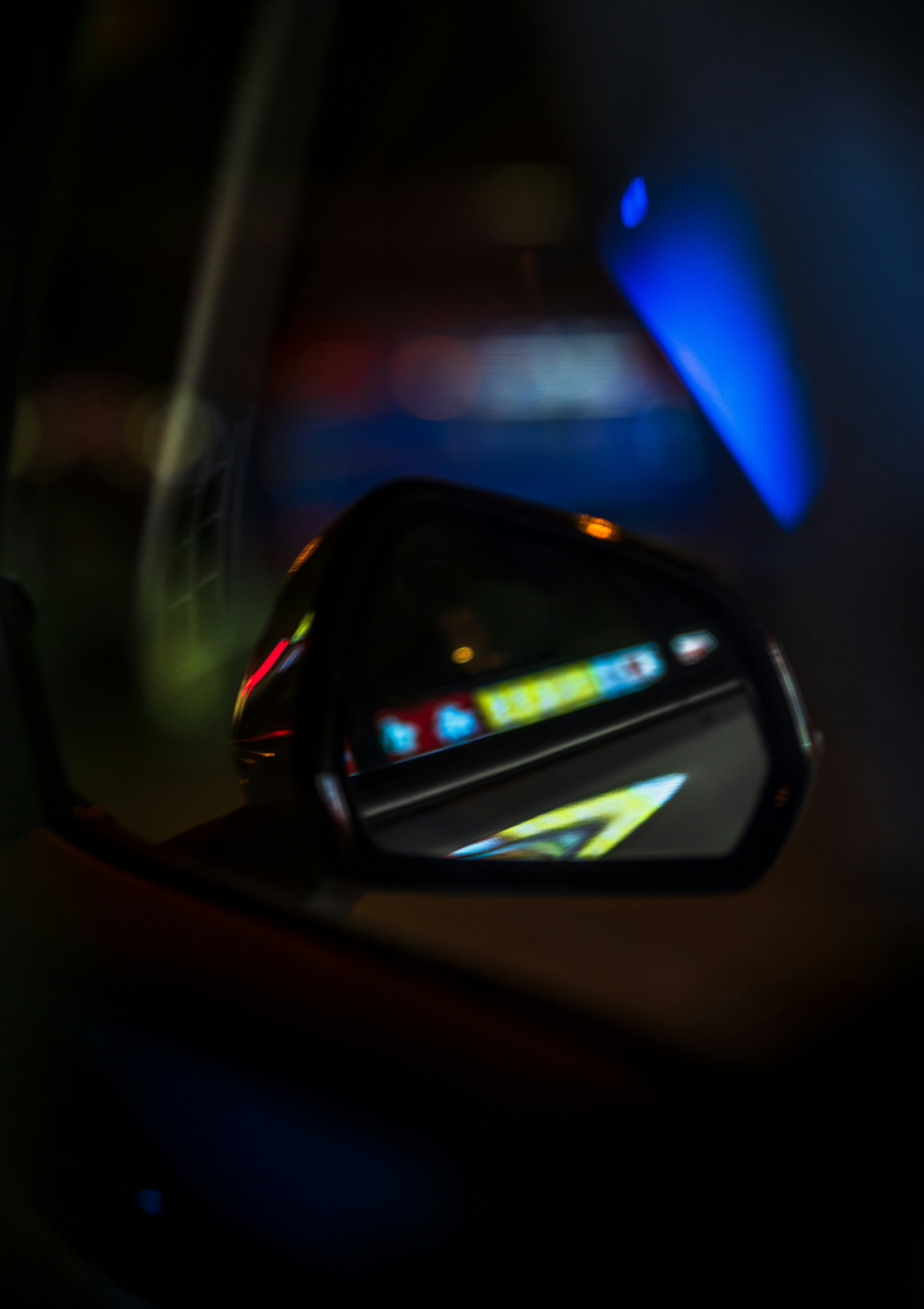 Neon Echo in a Night-Drive Side Mirror