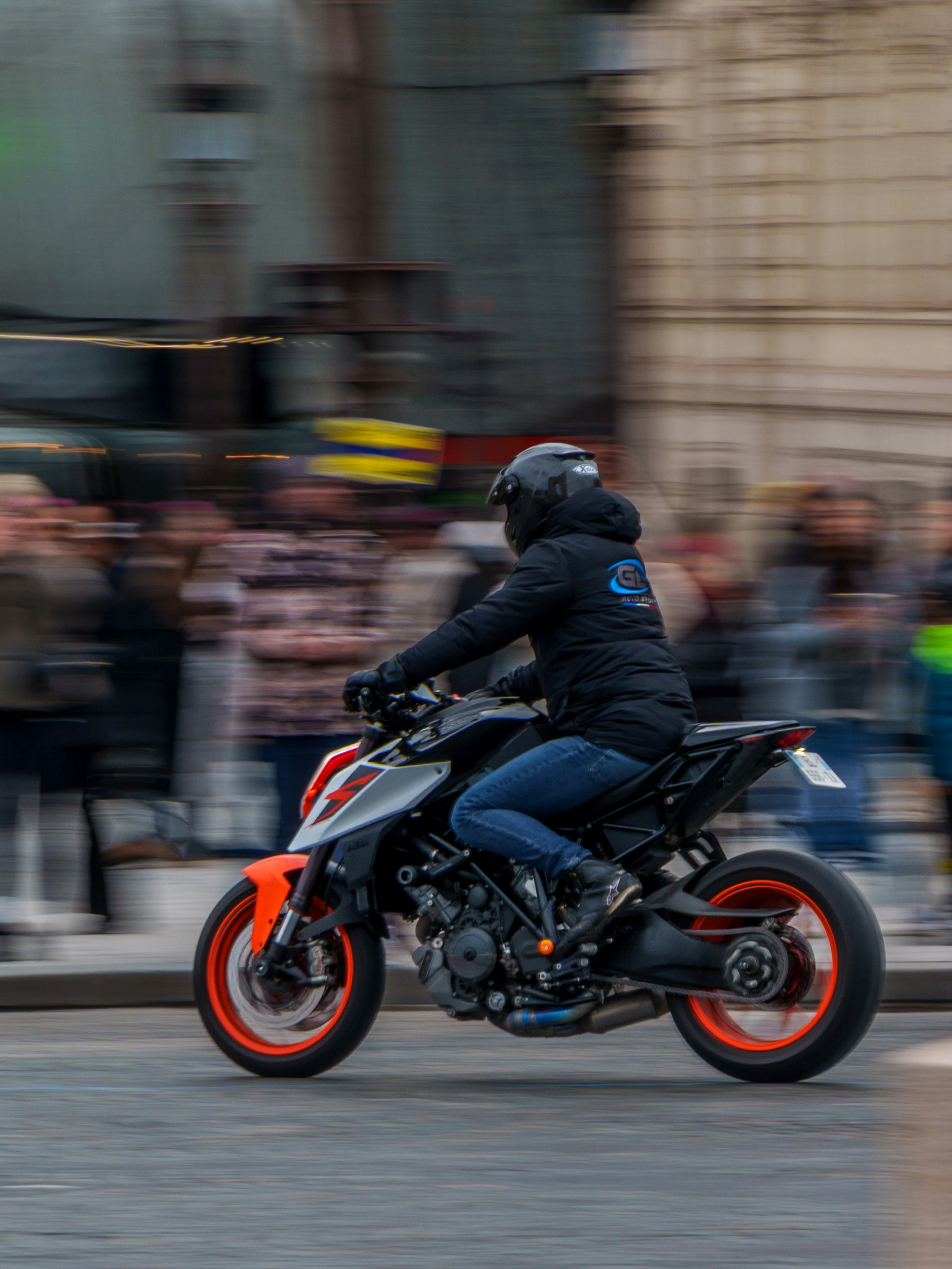 A person riding a motorcycle on a city street photo – Free France Image ...