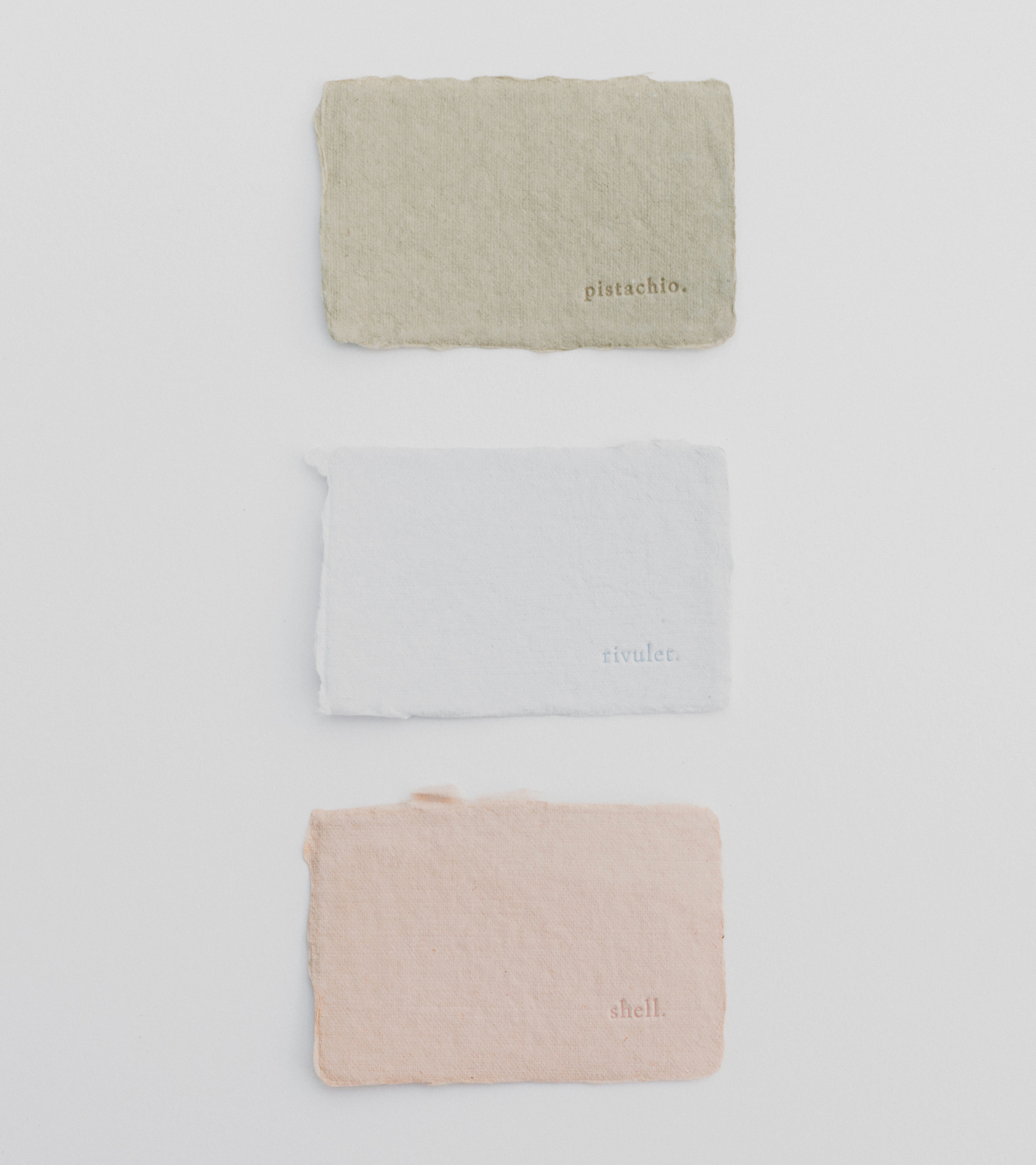 Three different colors of paper on a white surface photo – Free ...