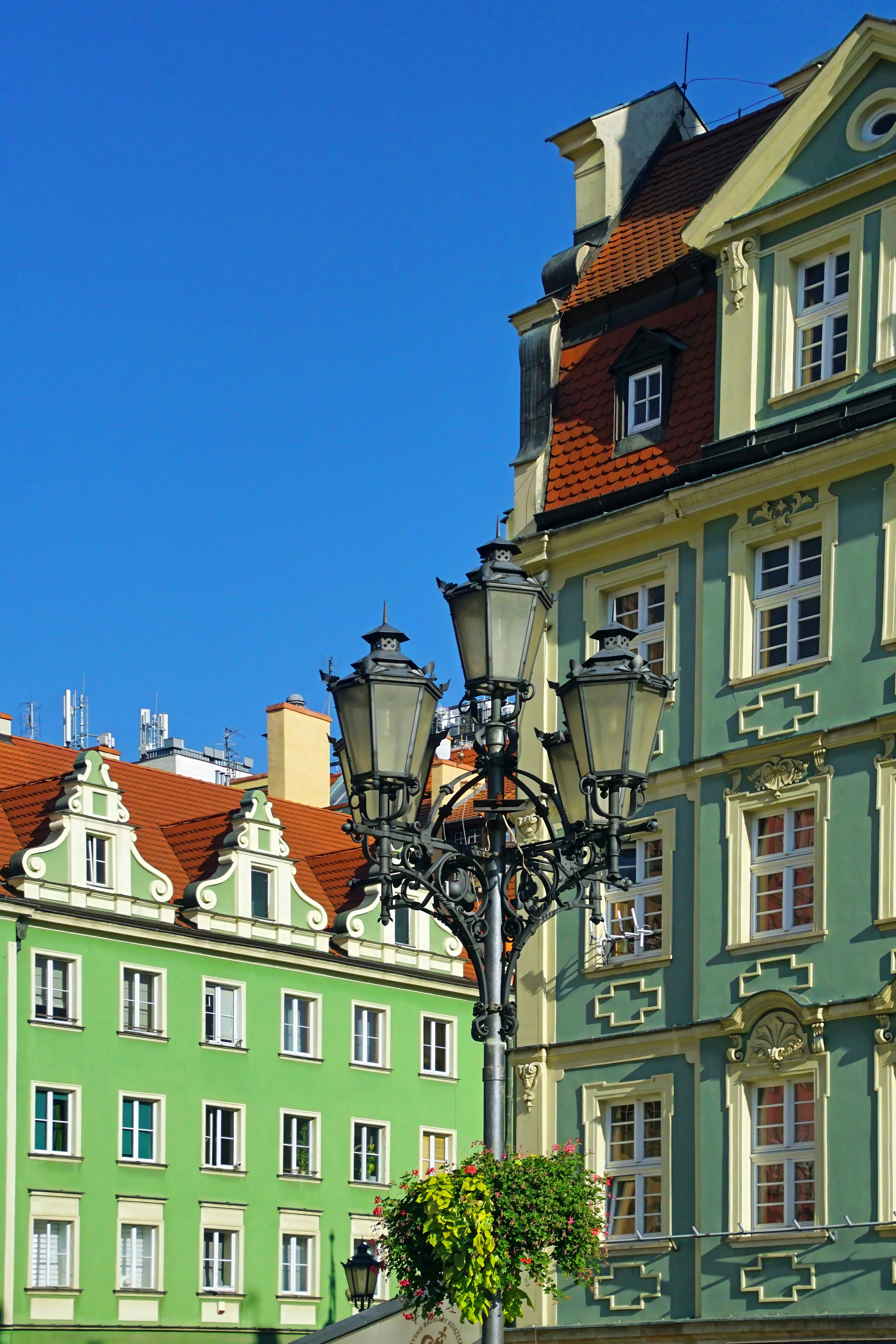 Old, green houses beside the main square in Wroclaw, Poland.