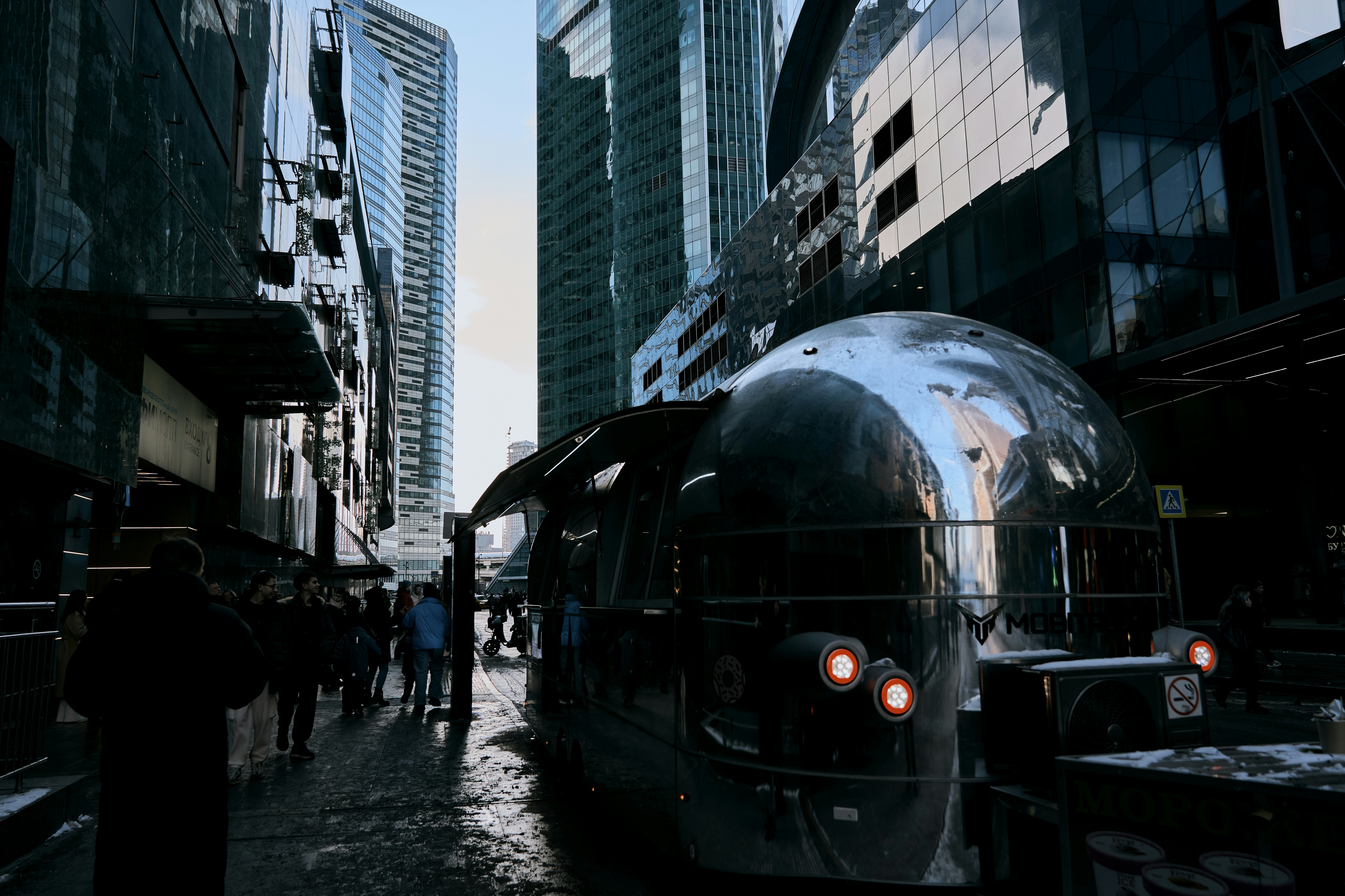 A train traveling through a city next to tall buildings photo – Free ...
