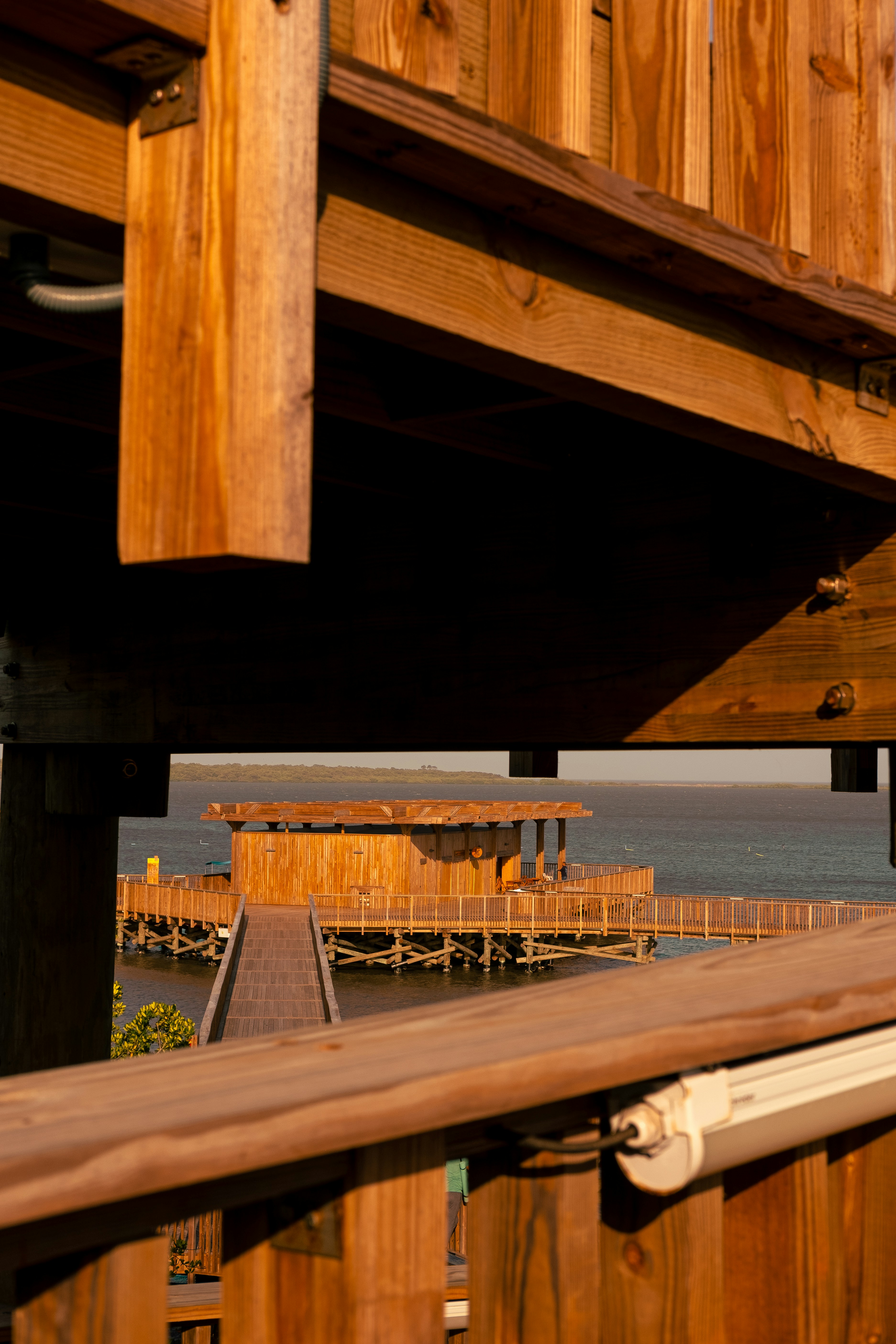 Wooden structures and walkways create a pattern against the backdrop of a serene waterbody.