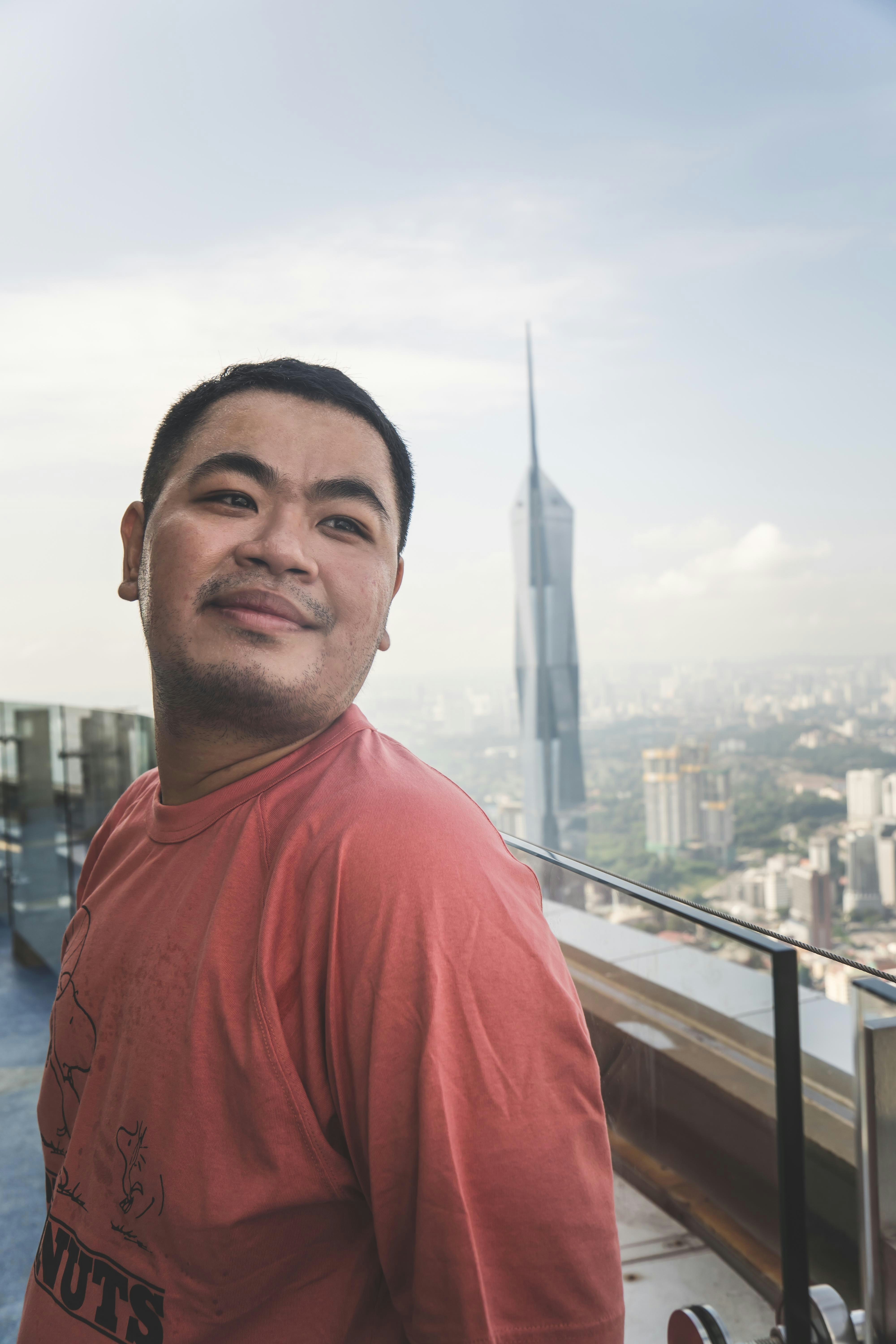 A man standing on top of a tall building photo – Free Kuala lumpur ...