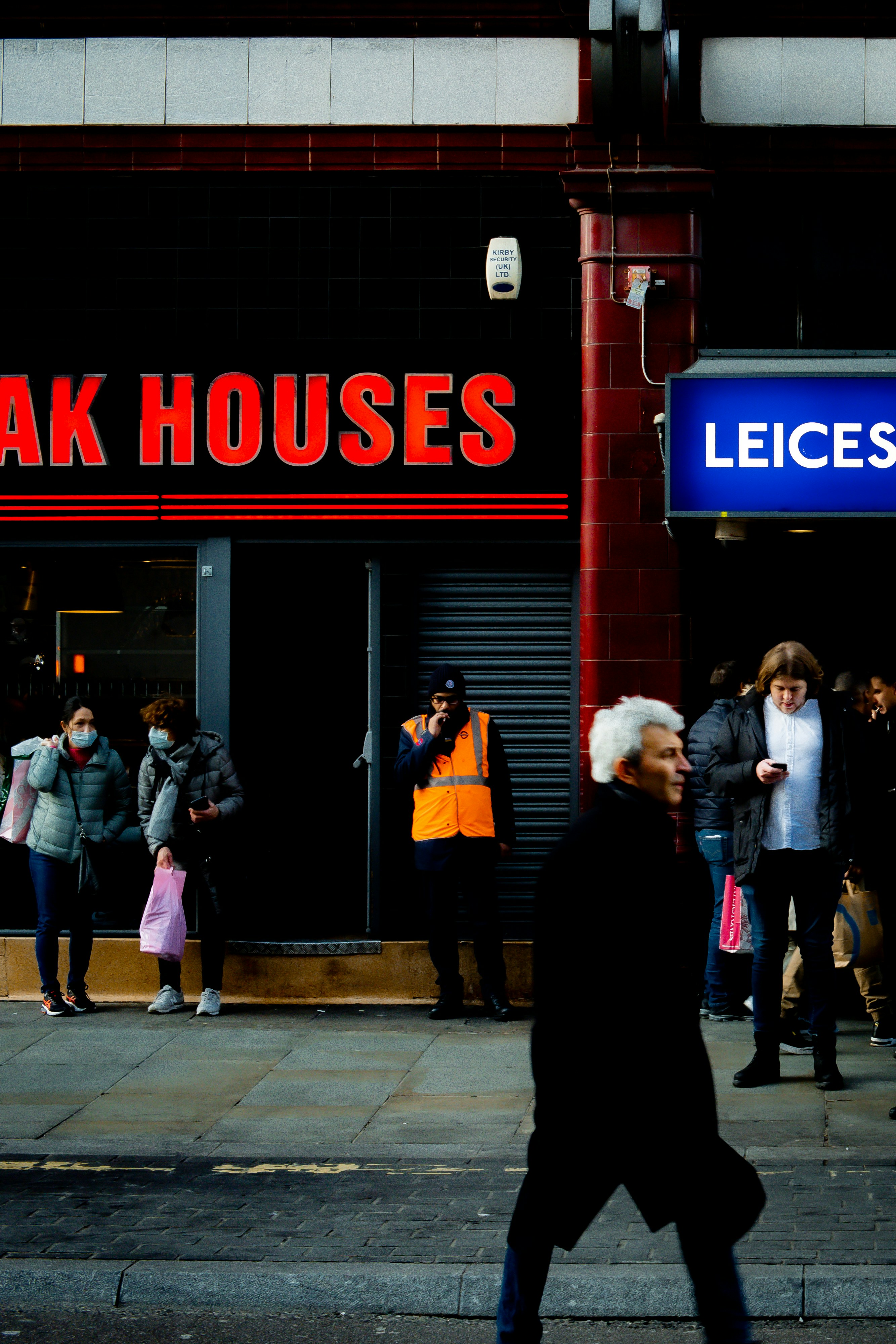 Took in 2022, during COVID-19 in London | A group of people standing outside of a store