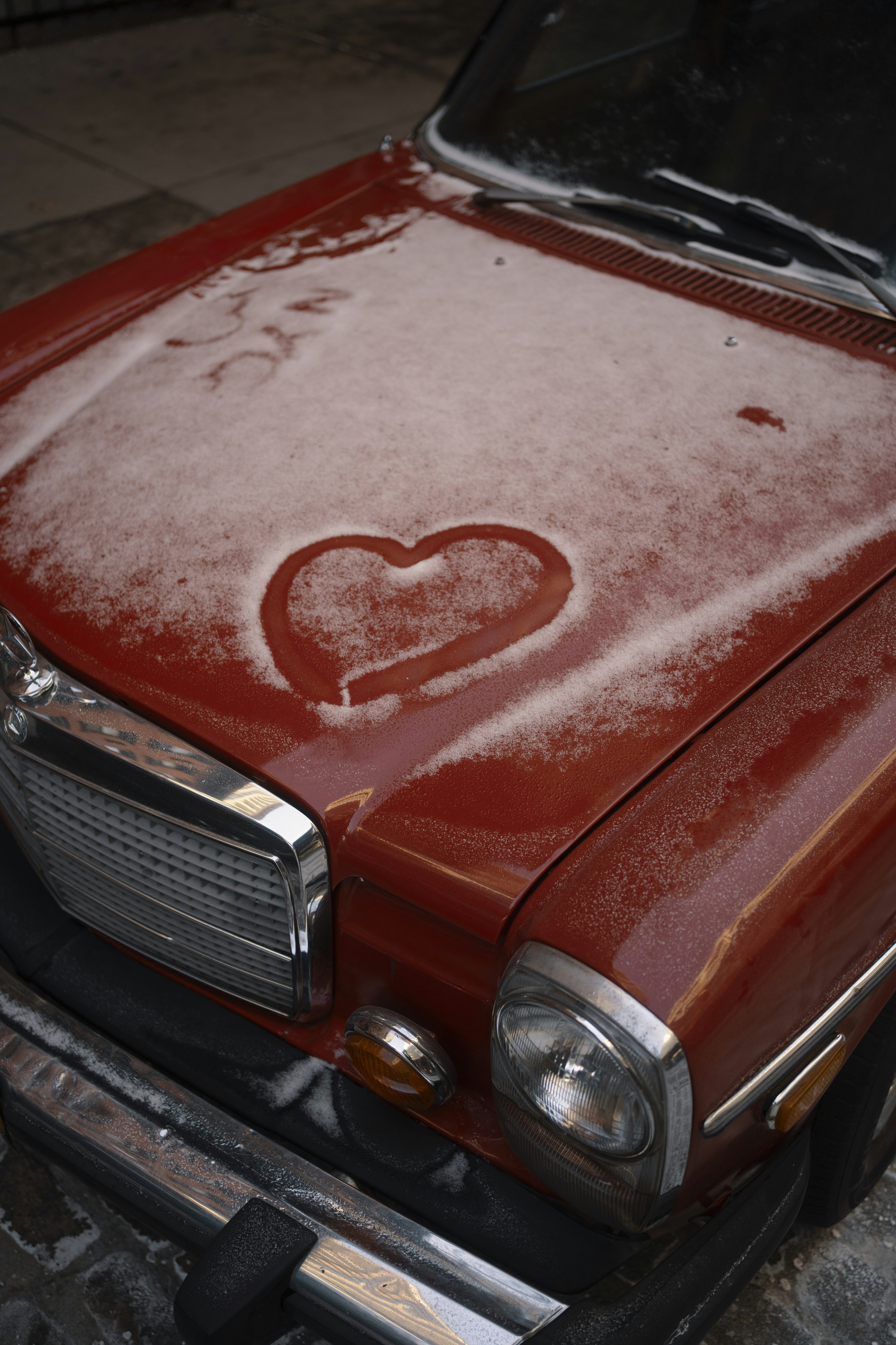 Heart on the Hood: A Vintage Red Car in Frosty Morning Light