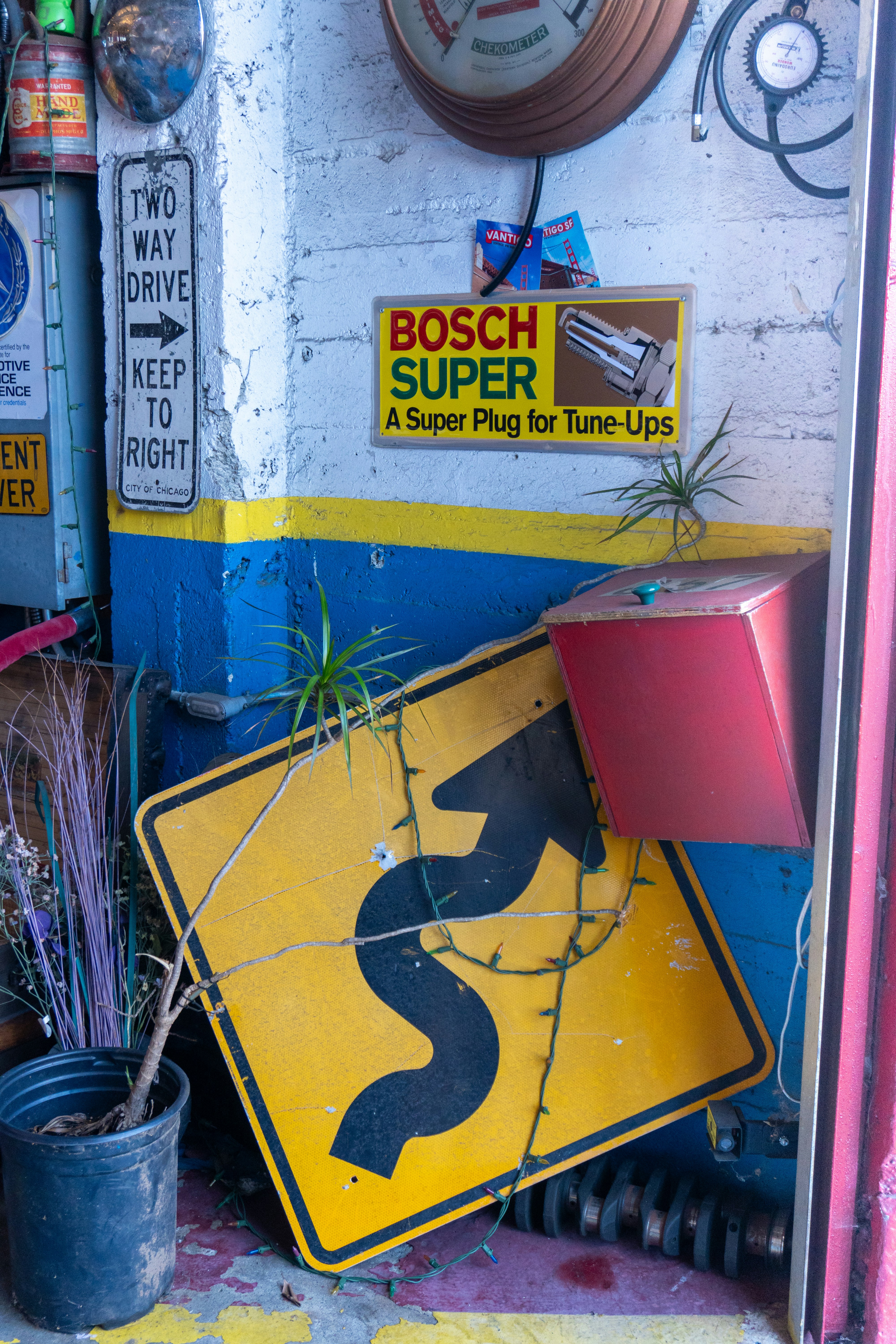 Bosch Signage and Leaning Road Sign in a Nostalgic Auto-Shop Scene