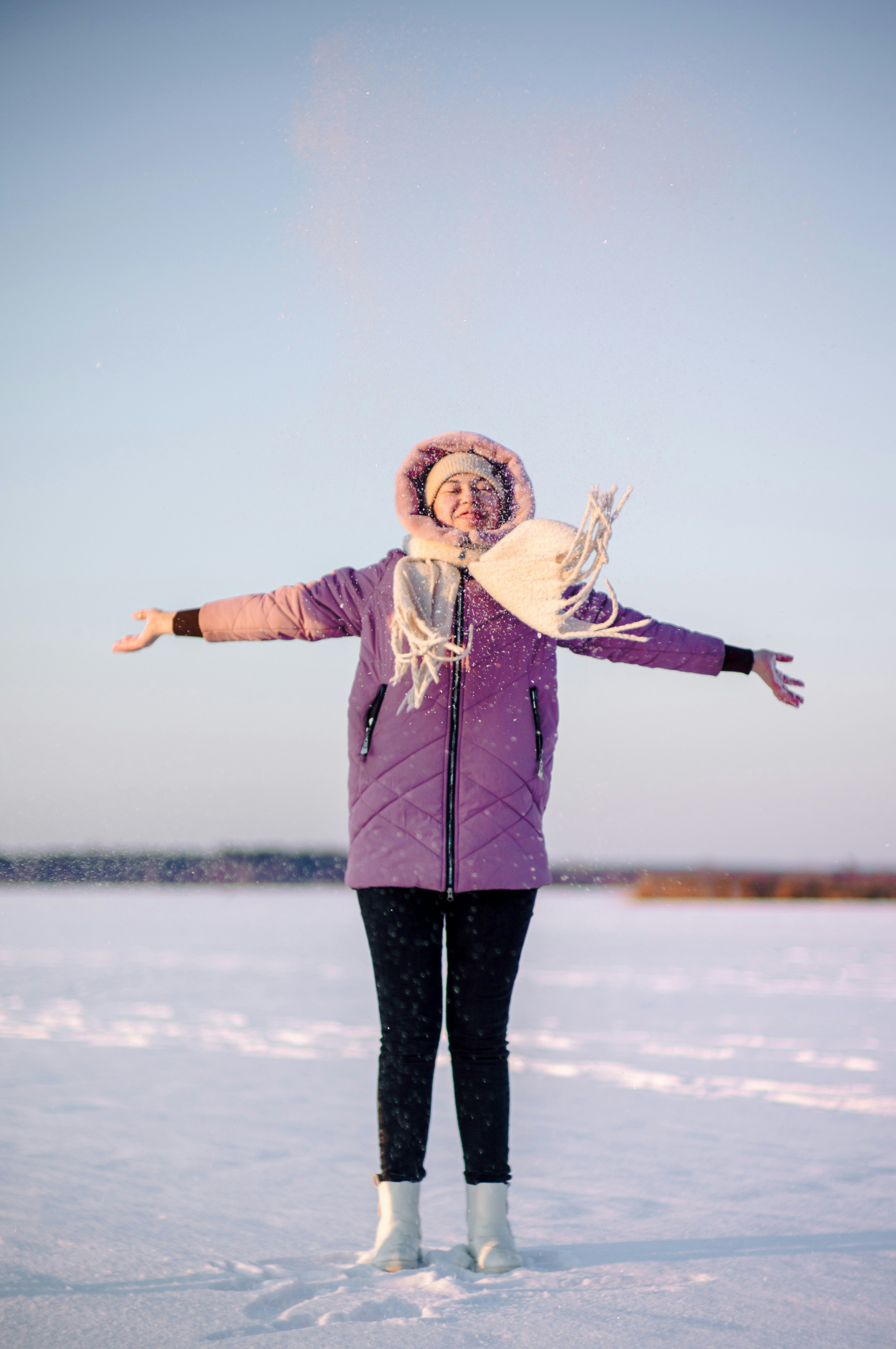 Arms Wide in a Snowfield: Purple Coat Portrait