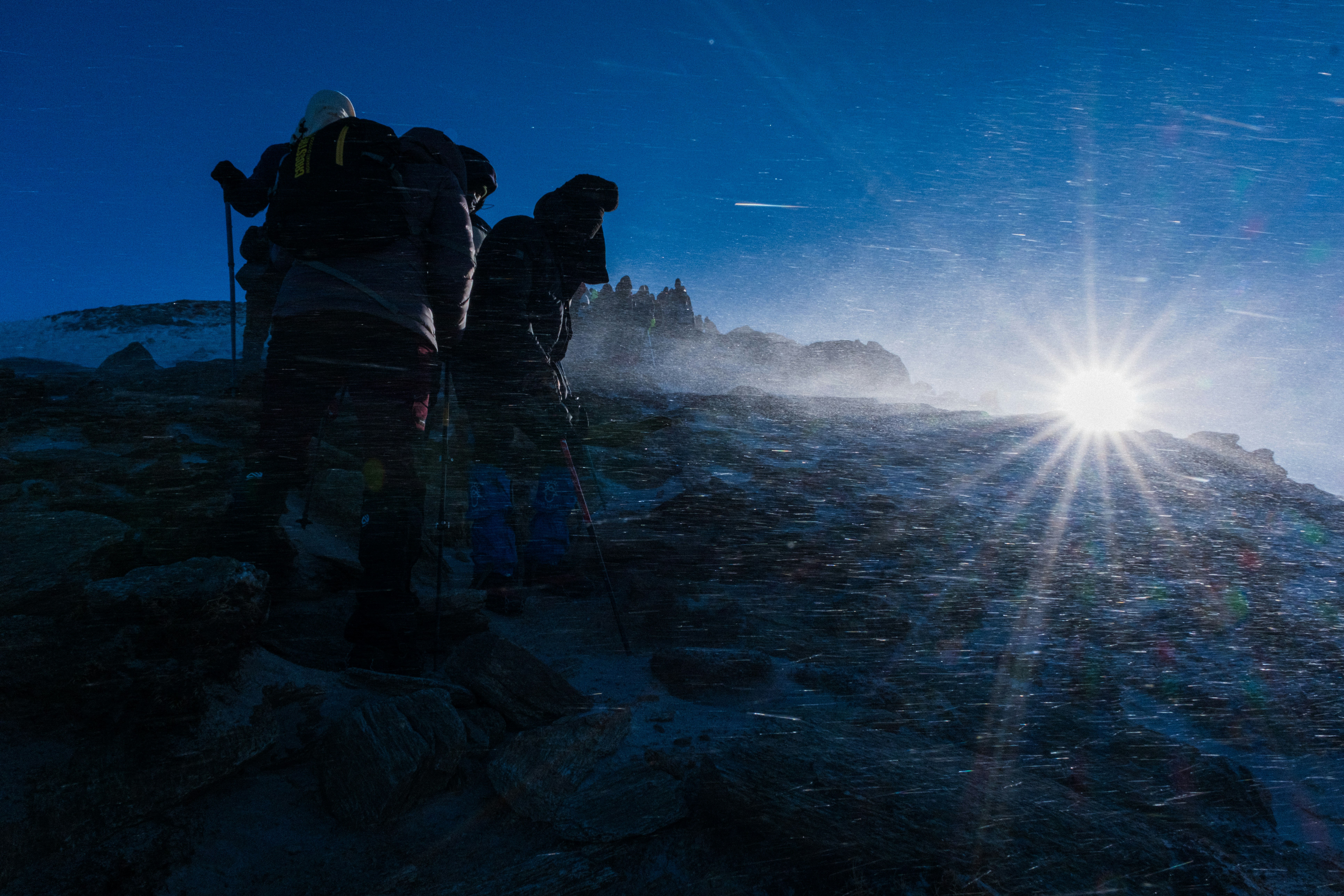 Sunburst on a Wind-Swept Shore: Photographers in Blue Hour