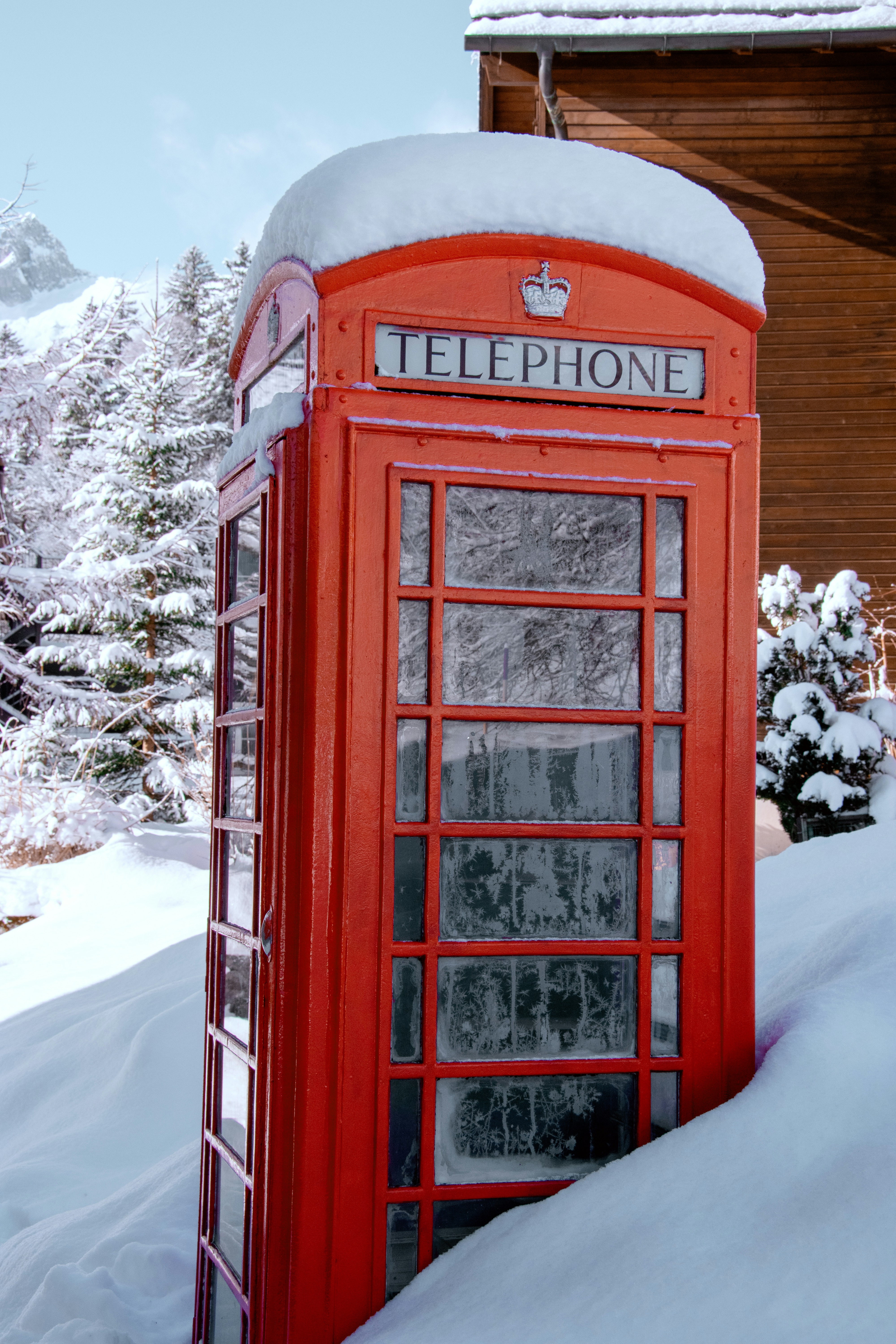 Crimson Kiosk in a Winter Fable: Snow-Bound Telephone Booth