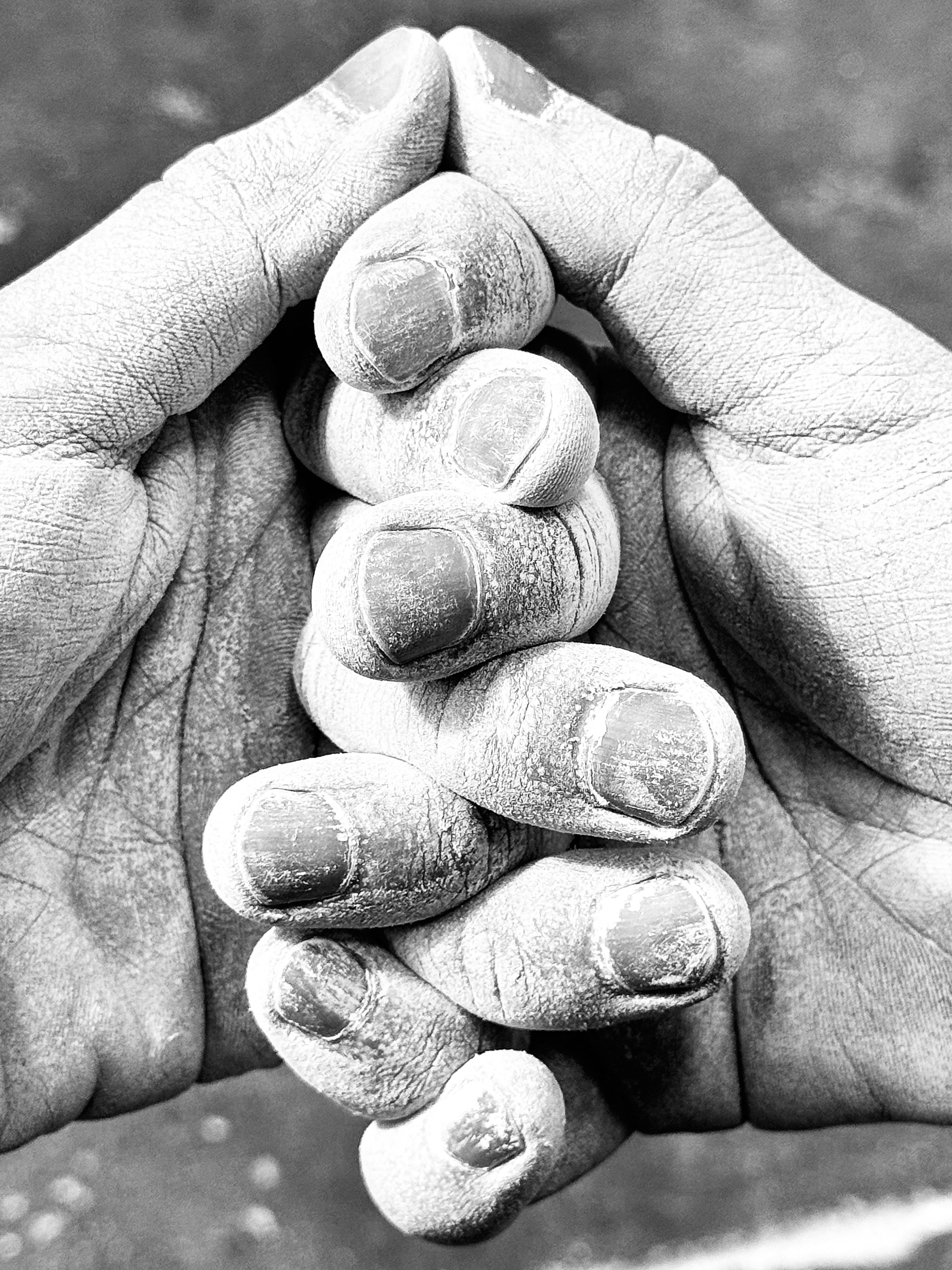 Chalked Grasp: A Monochrome Close-Up of Interwoven Hands