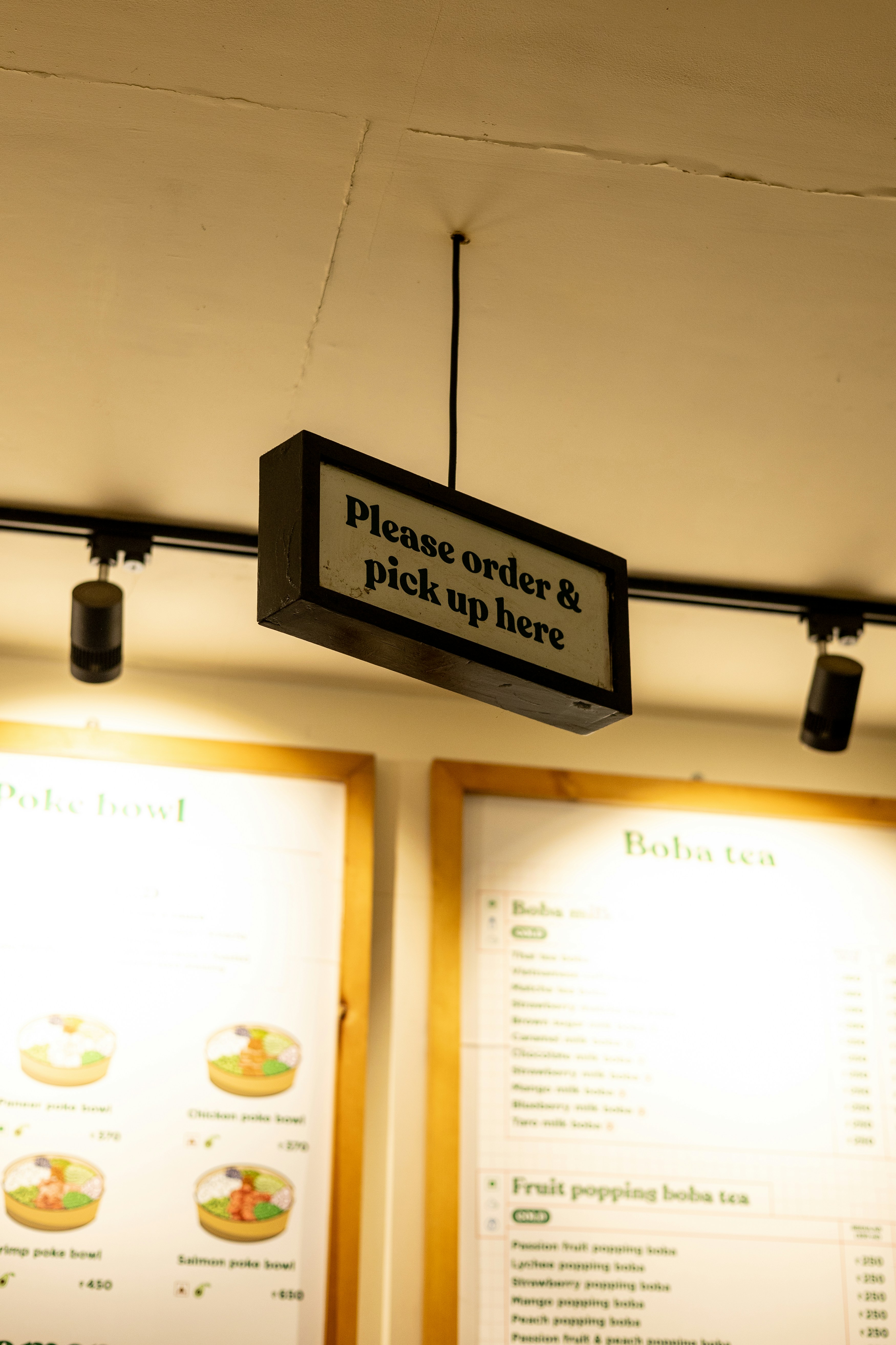 A menu hanging from the ceiling of a restaurant