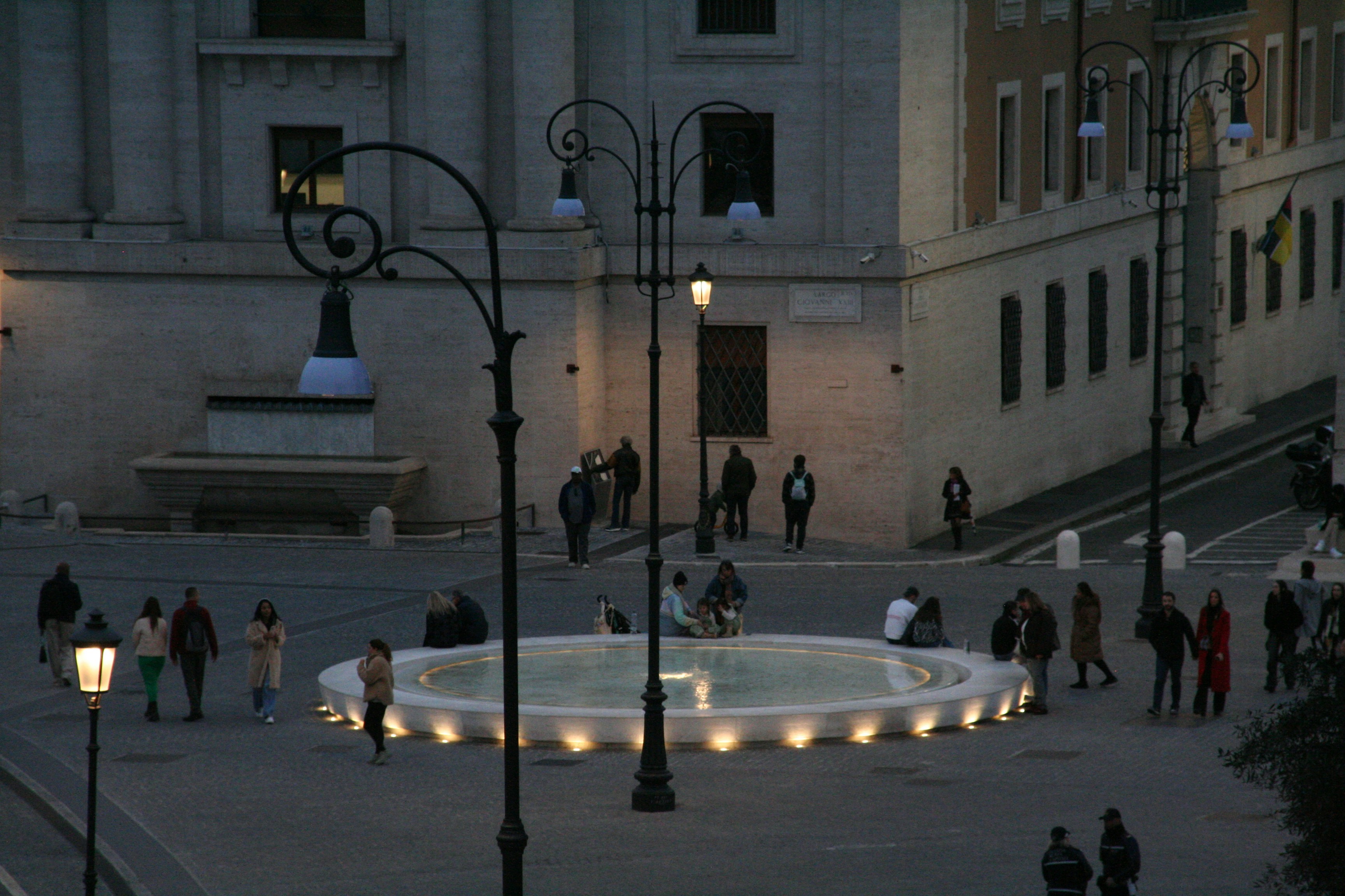 Halo at Dusk: Lantern-Lit Fountain Circles a Quiet City Square