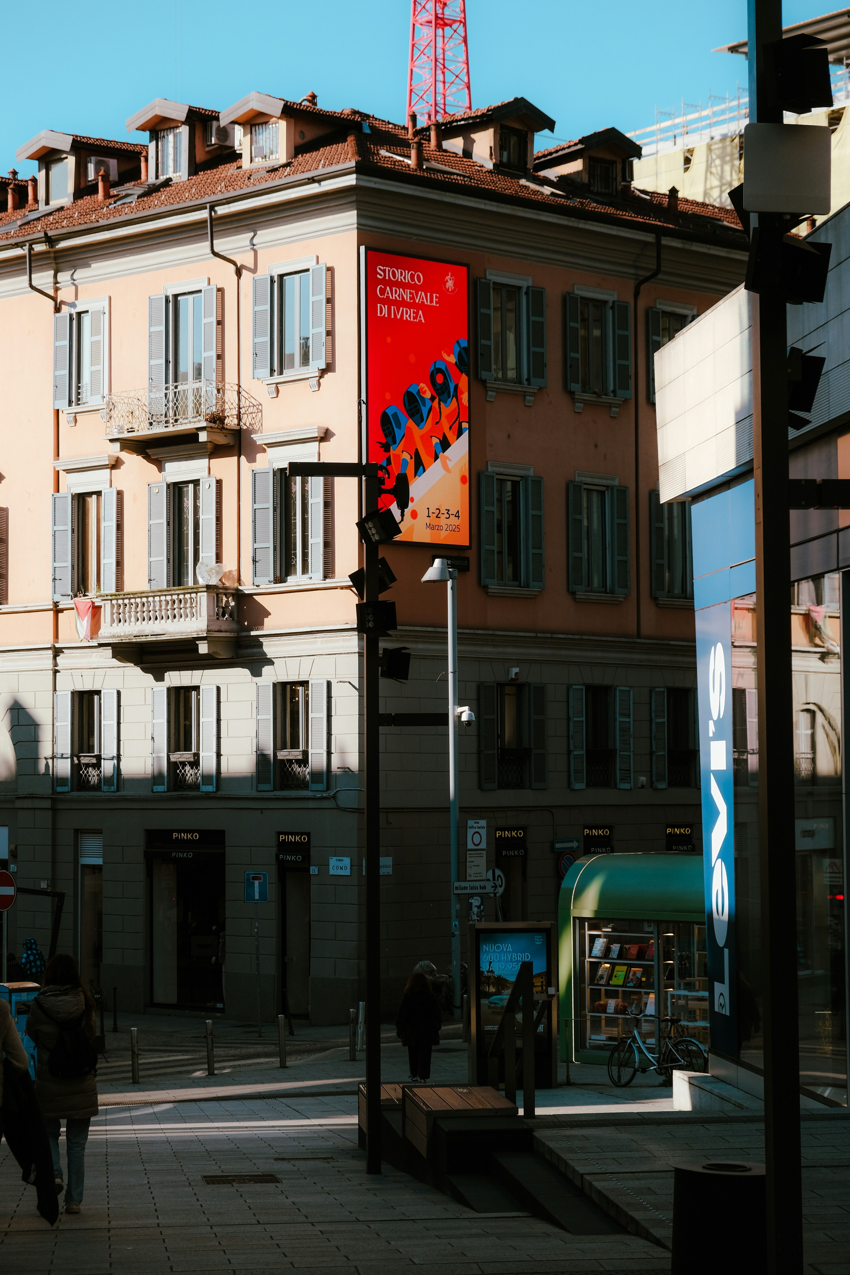 Sunlit Italian Street Banner Over a Classic Facade