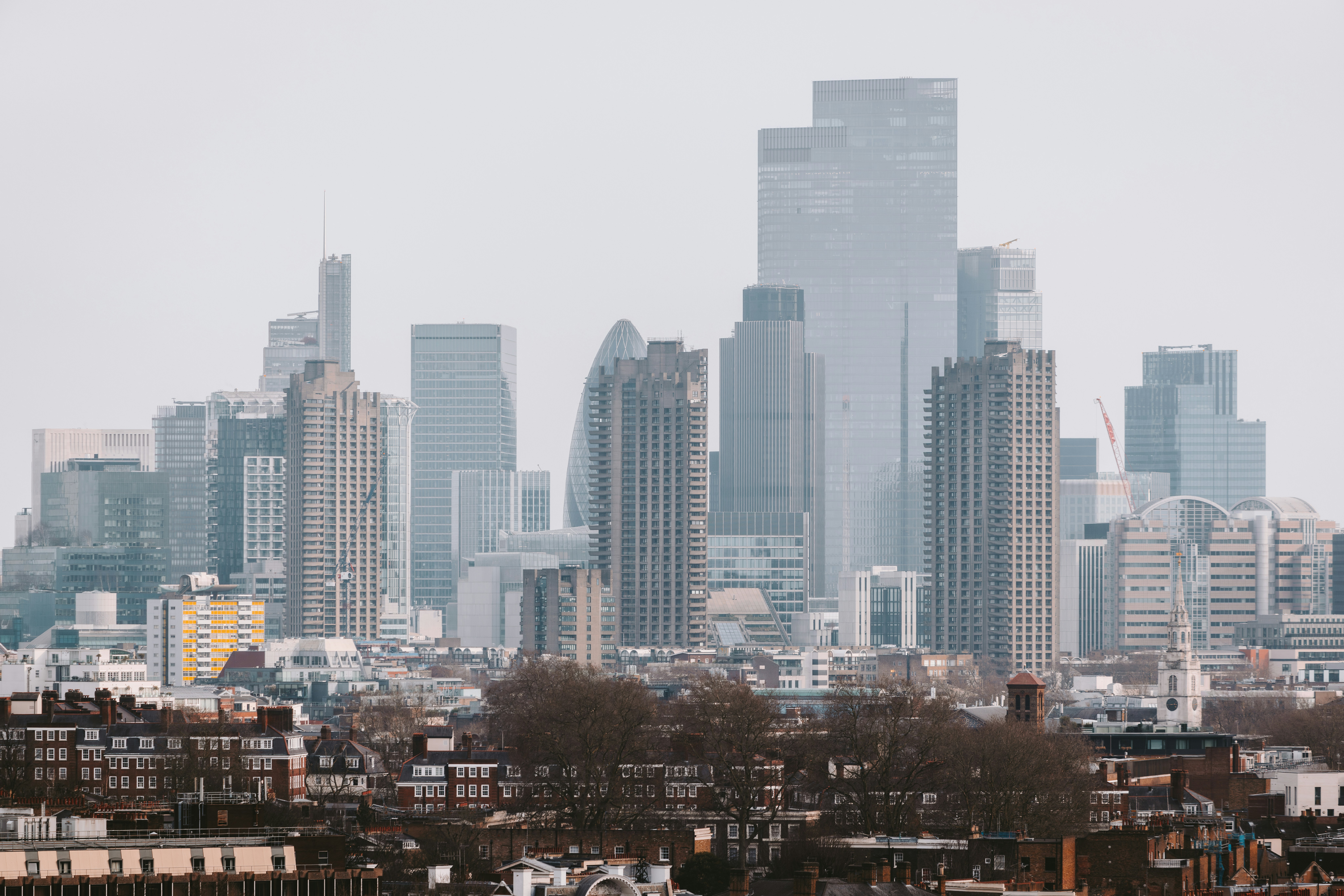 Skyline of London featuring modern skyscrapers juxtaposed with historic architecture.