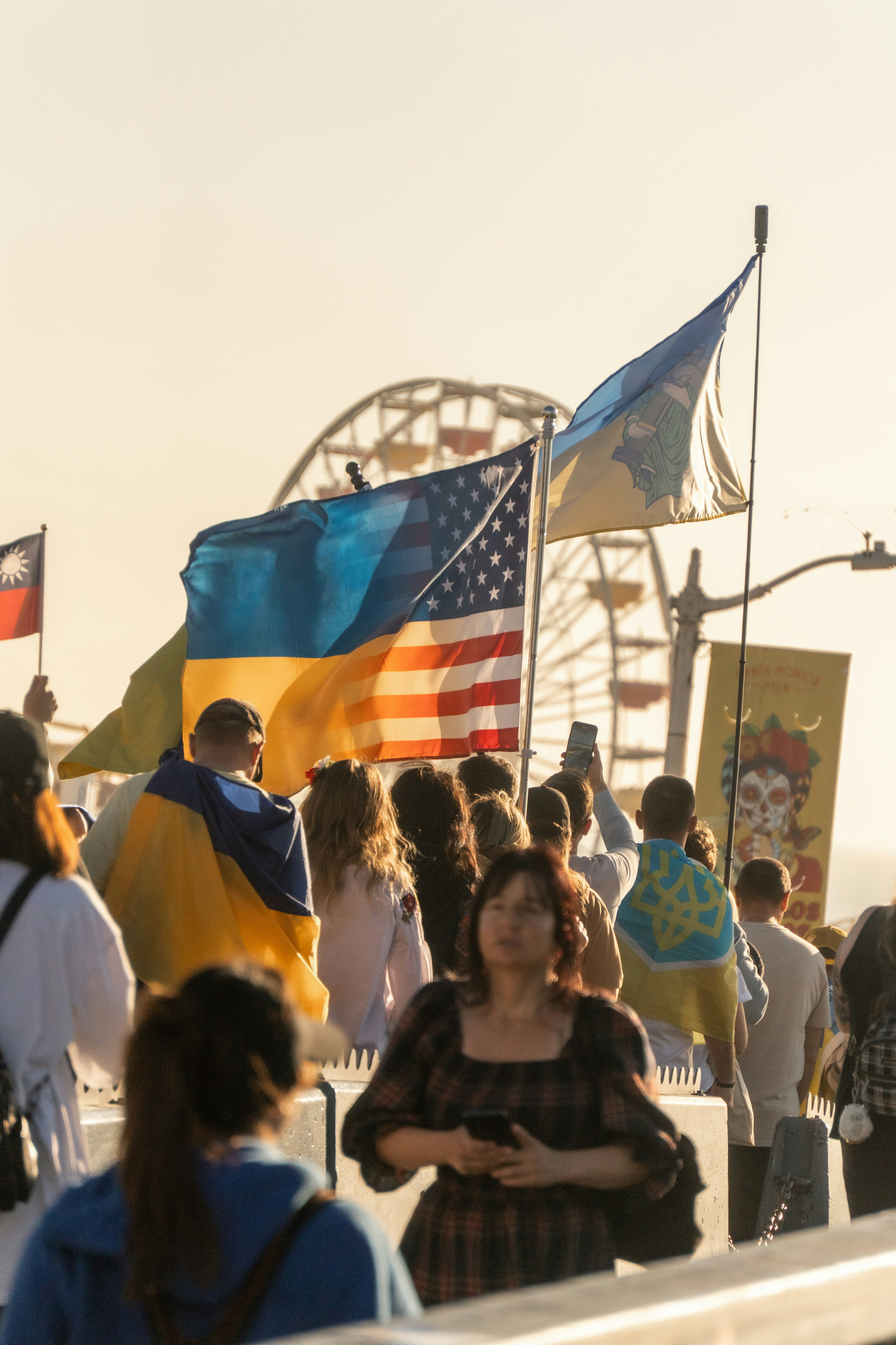 The weight of war is felt even thousands of miles away. A demonstrator’s sign highlights the suffering of Ukrainian prisoners of war.