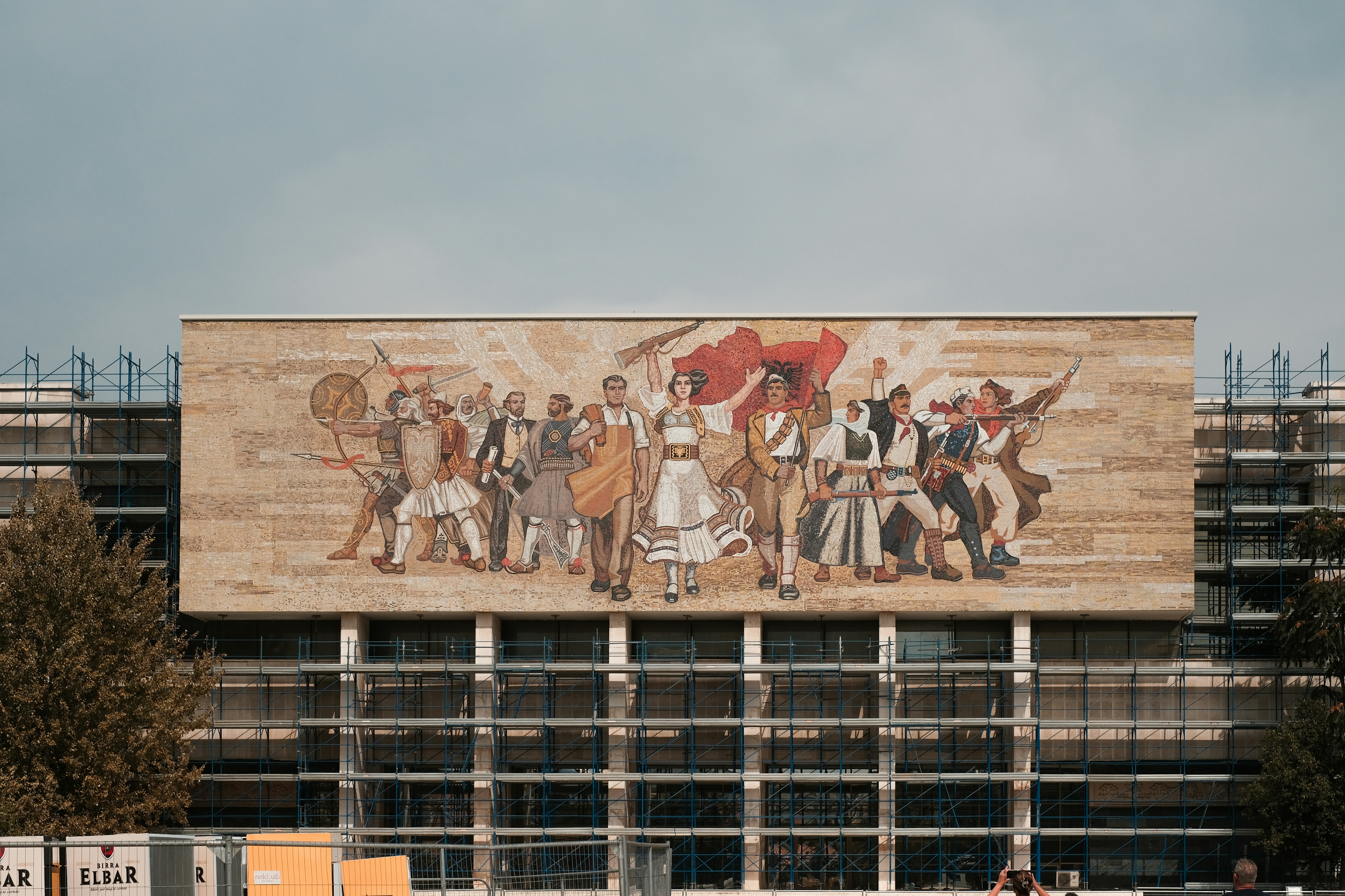 The mosaic depicts aspects from Albania history. The man to the centre-right is Skanderbeg, a national hero who fight the Ottoman Empire in the 15th century.