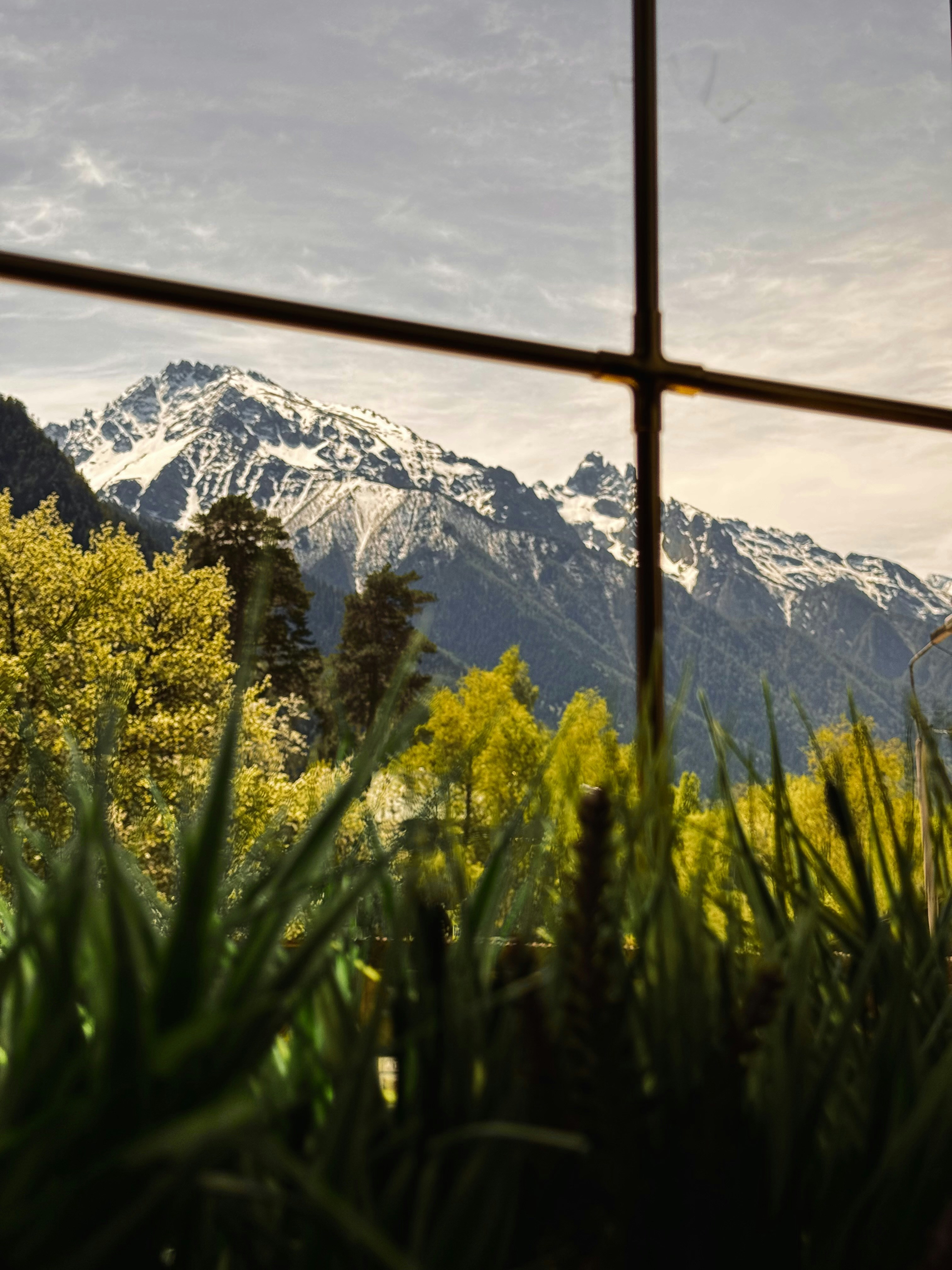 A view of a mountain through a window photo – Free Travel Image on Unsplash