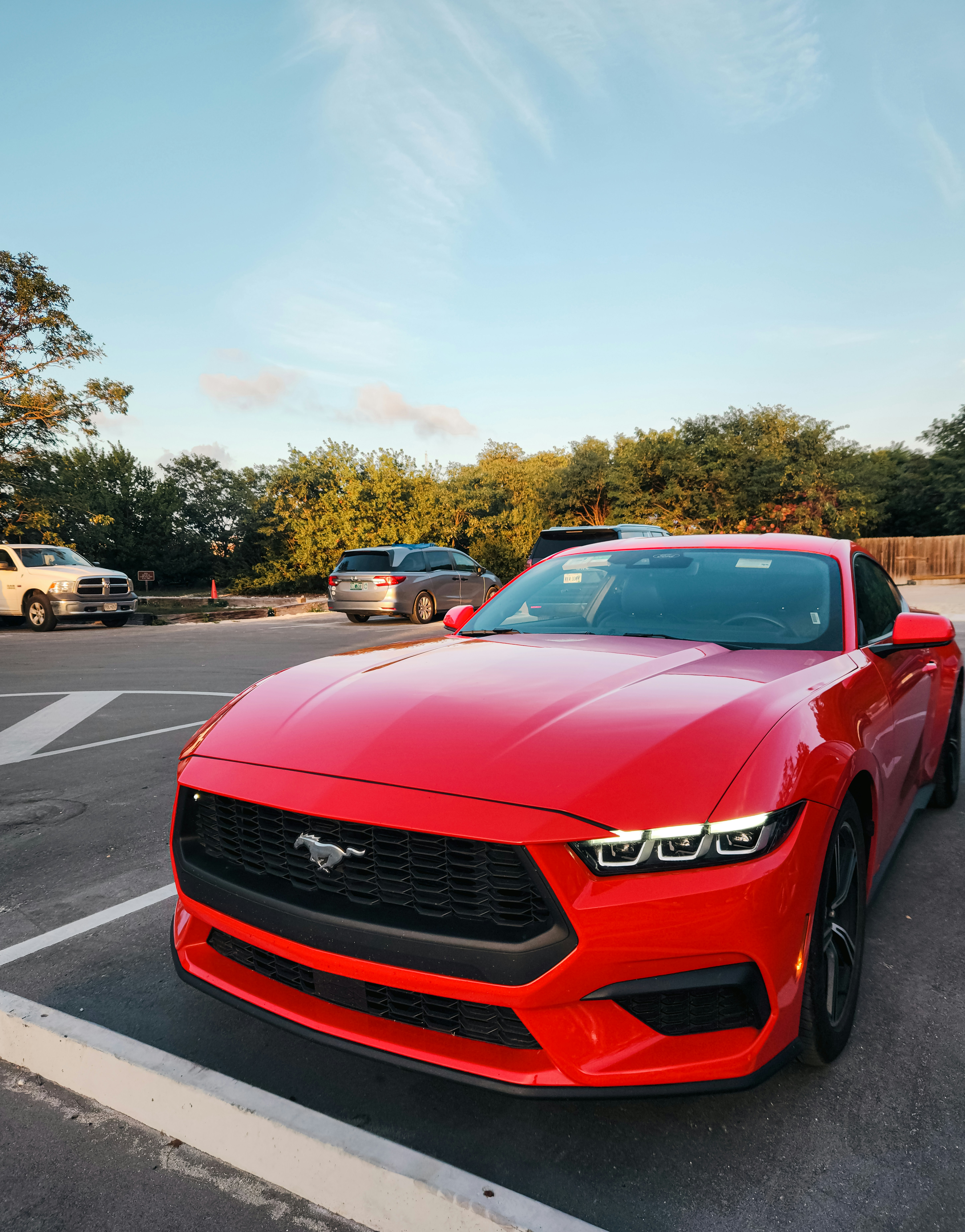 Crimson Stallion at Golden Hour: Front-Quarter Majesty in a Parking Lot