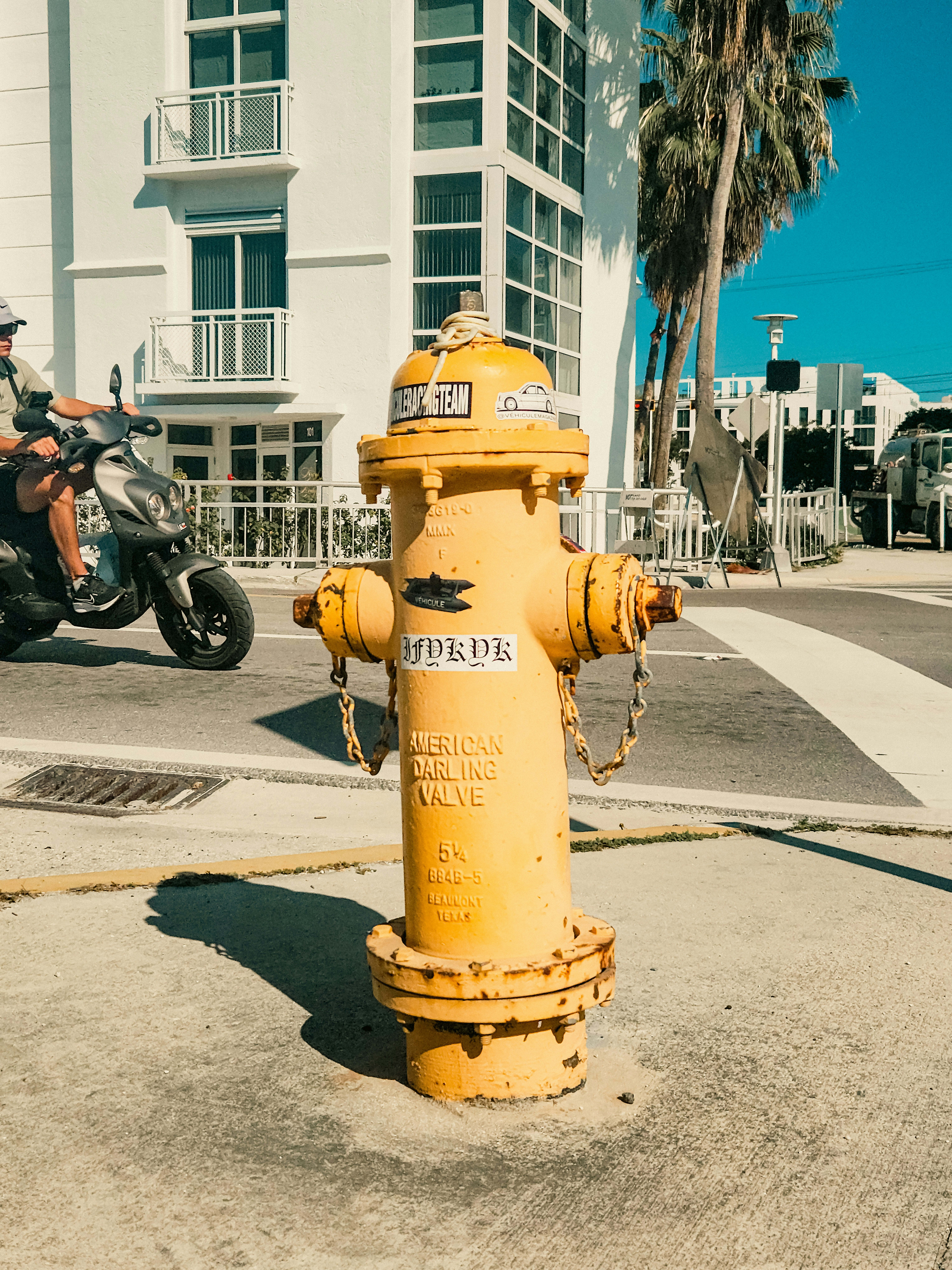Sunny Urban Hydrant: A Bold Fire Valve Stands Guard on the Street